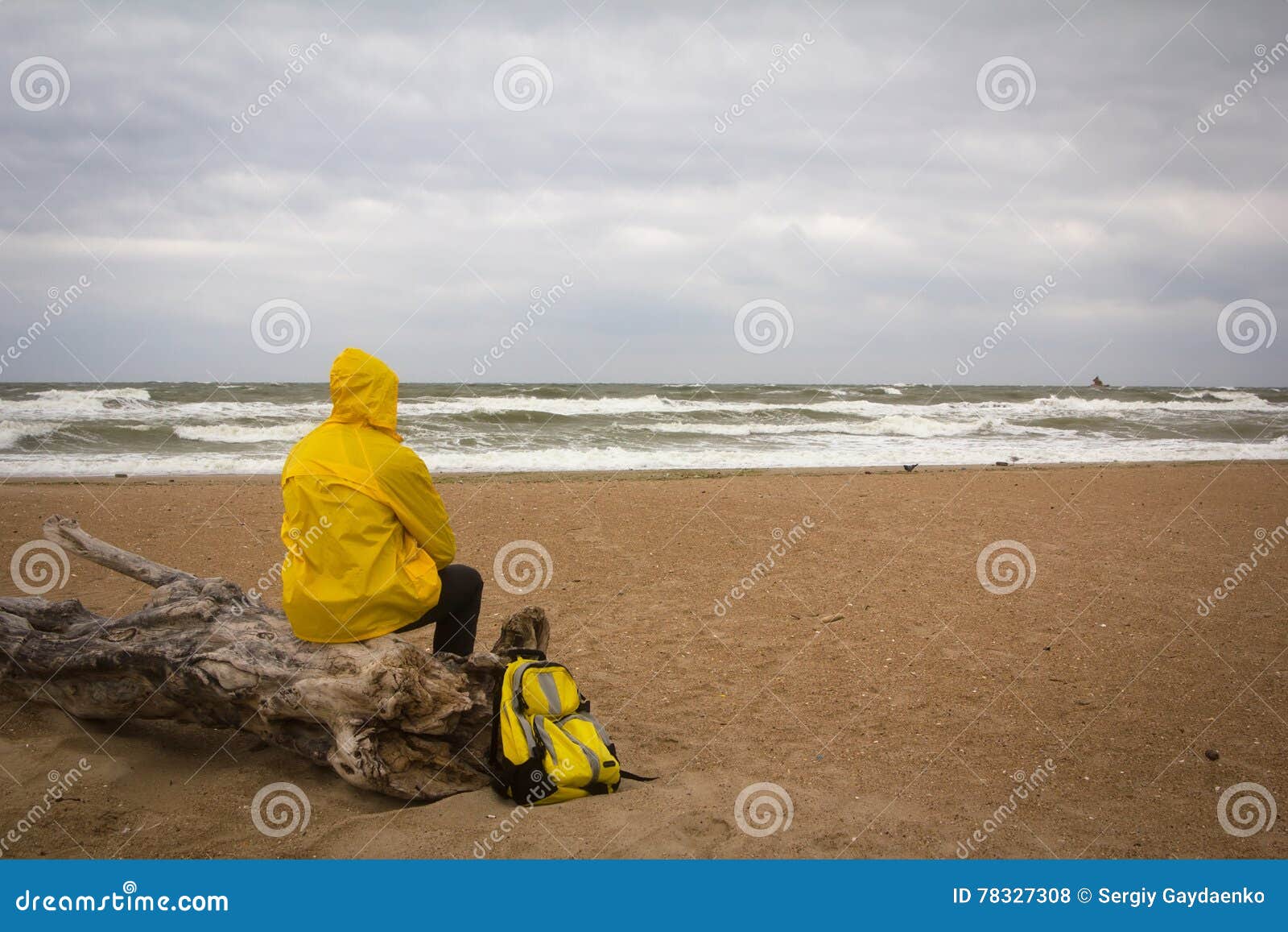 Men in Yellow Raincoat on the Beach Looking at Storm. Stock Photo ...