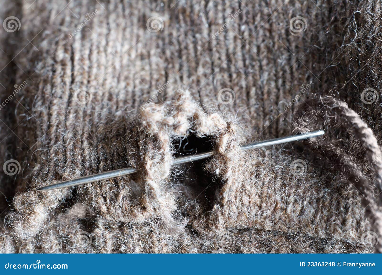 Mending a Hole in Clothing stock photo. Image of knitted - 23363248