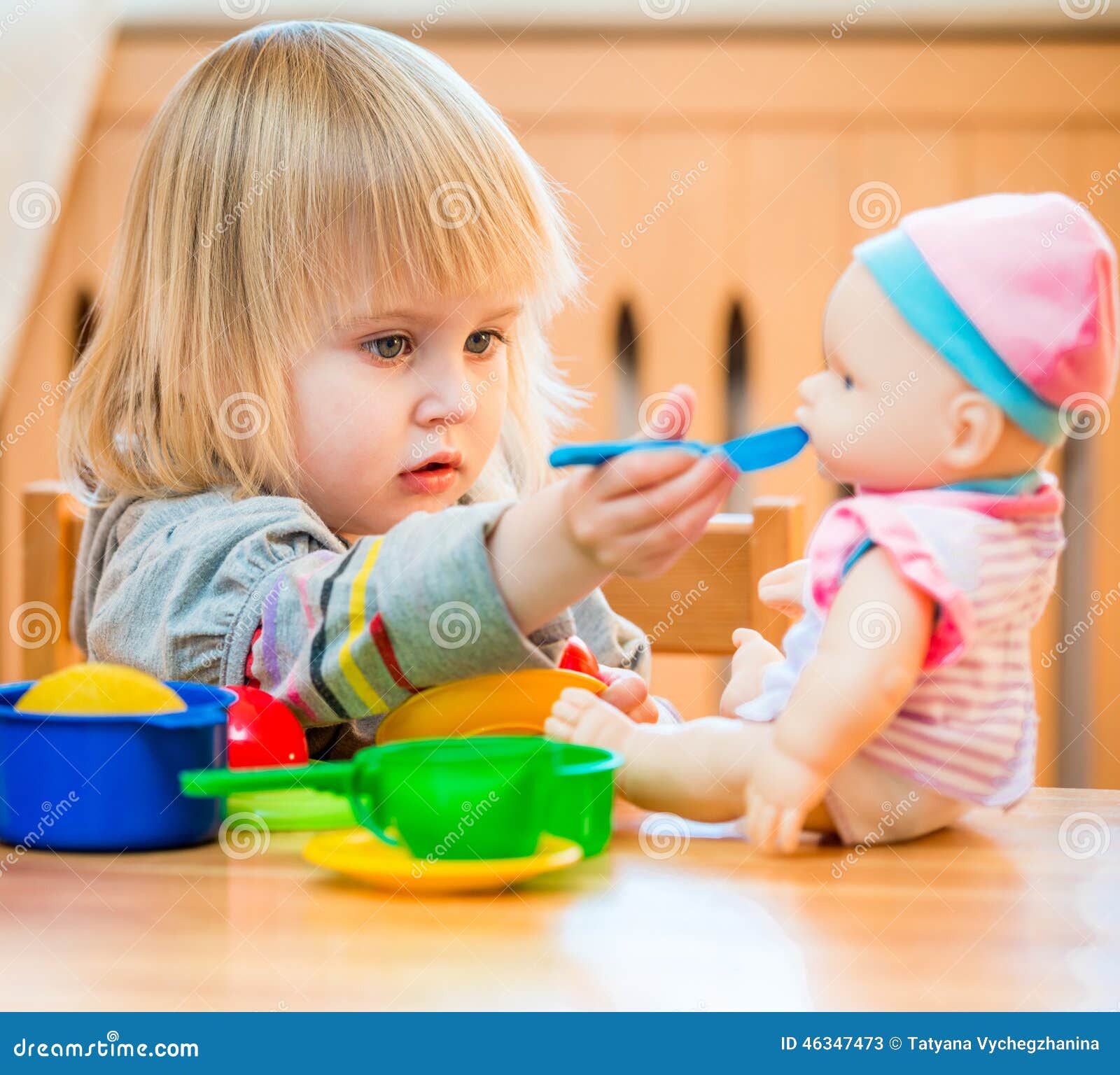 Menina Que Alimenta Uma Boneca Imagem de Stock - Imagem de gostoso ...