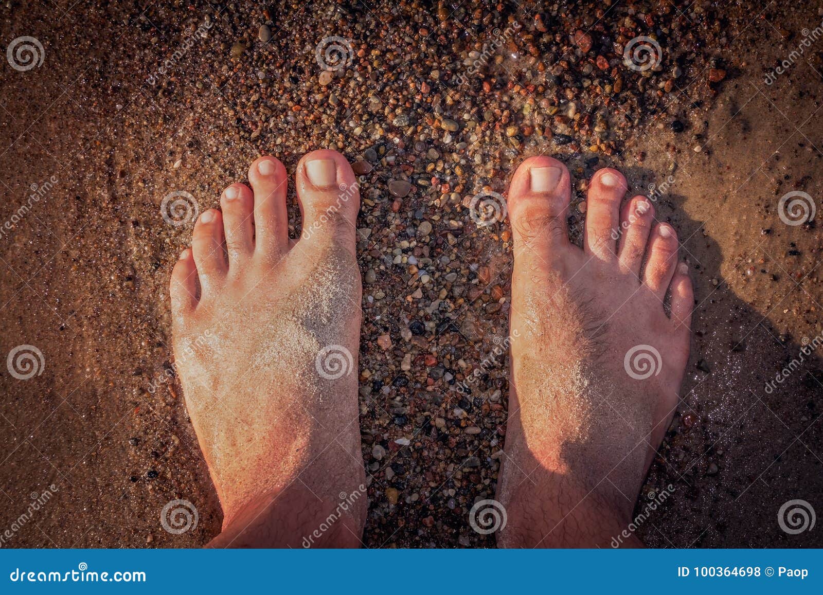 Mens feet on the beach stock photo. Image of resort - 100364698