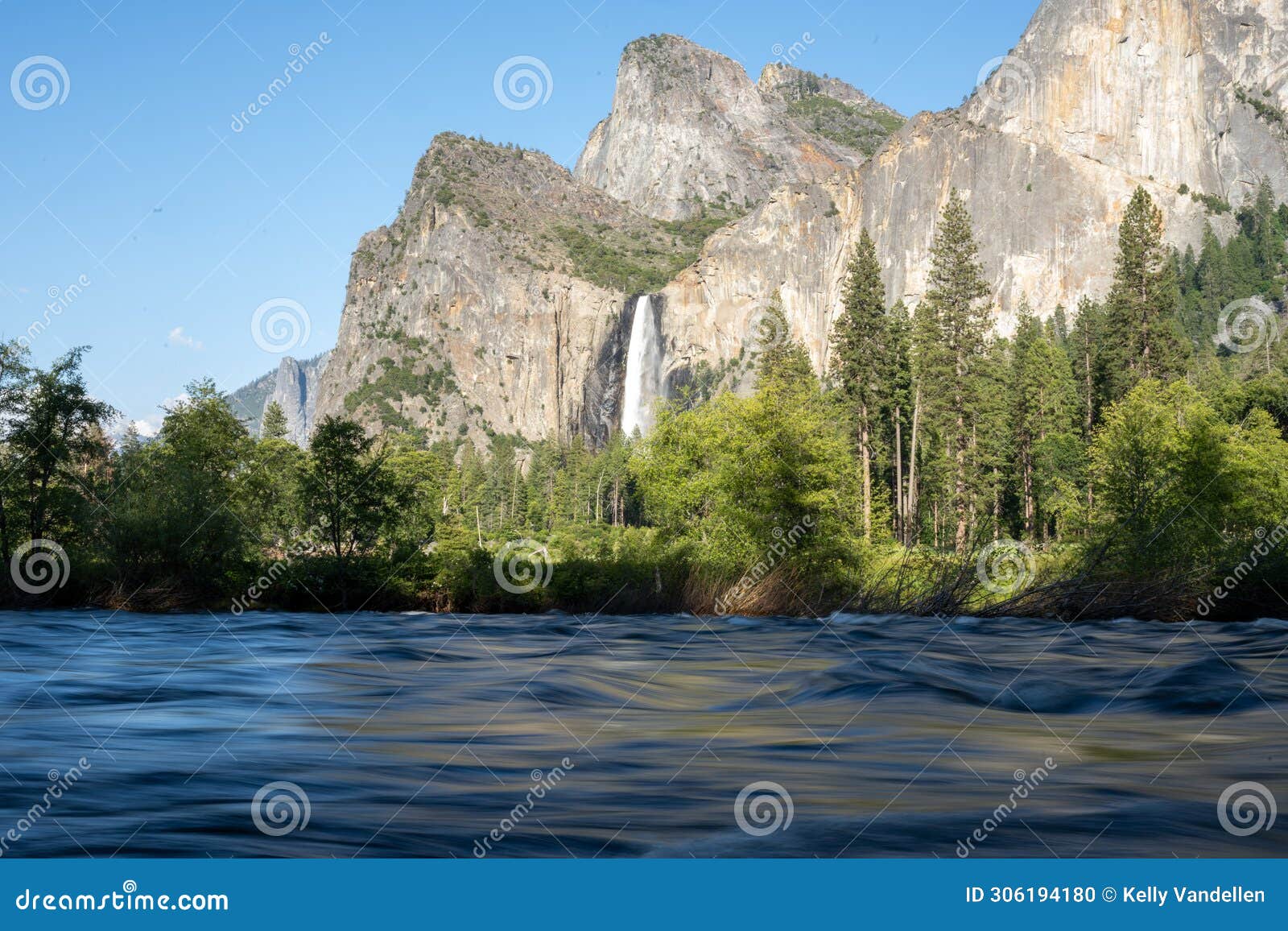 Merced River Smoothly Flows Below Roaring Bridalveil Falls Stock Photo ...