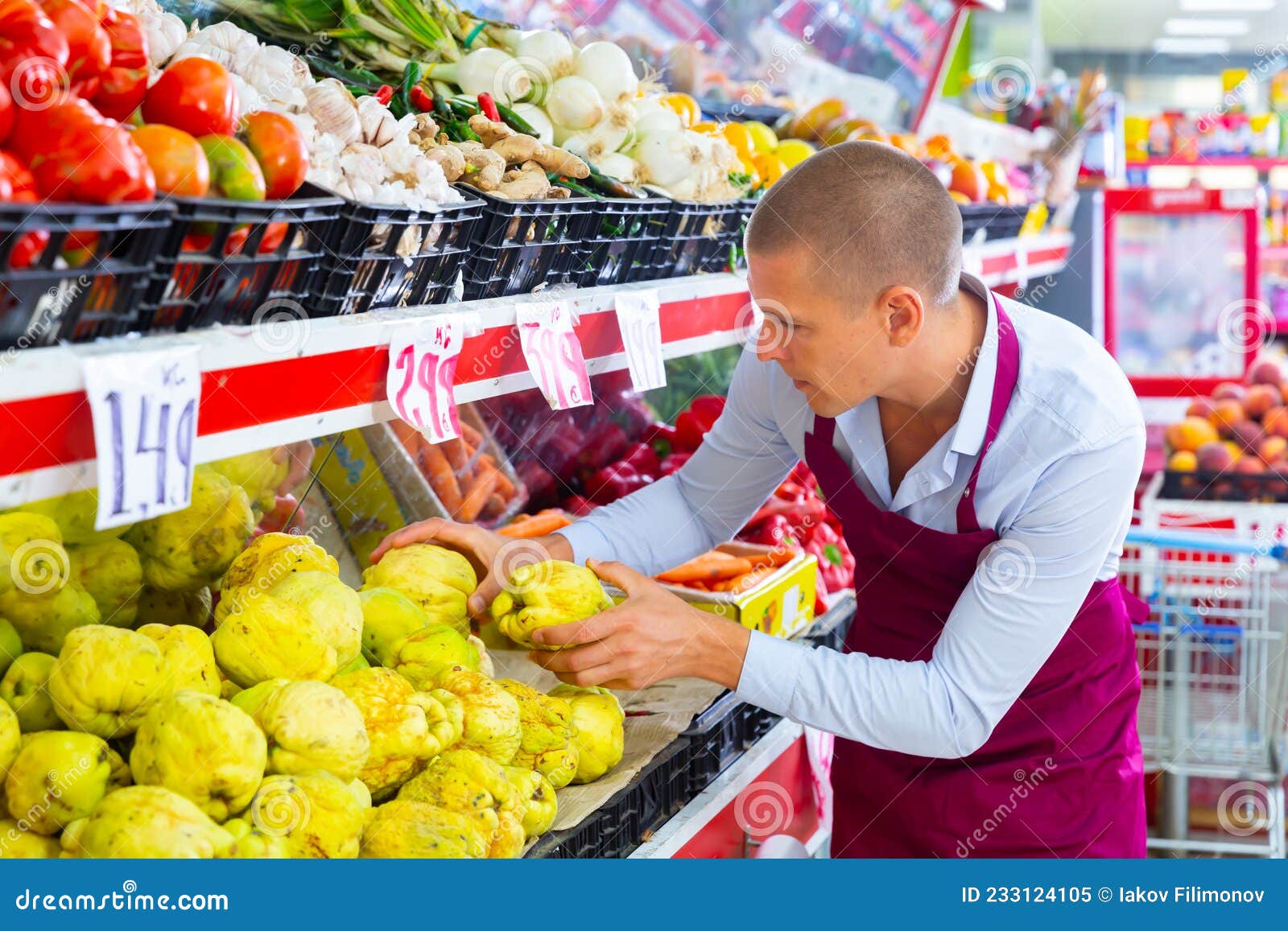 Supermarket Worker Putting Quinces on Shelf Stock Image - Image of ...