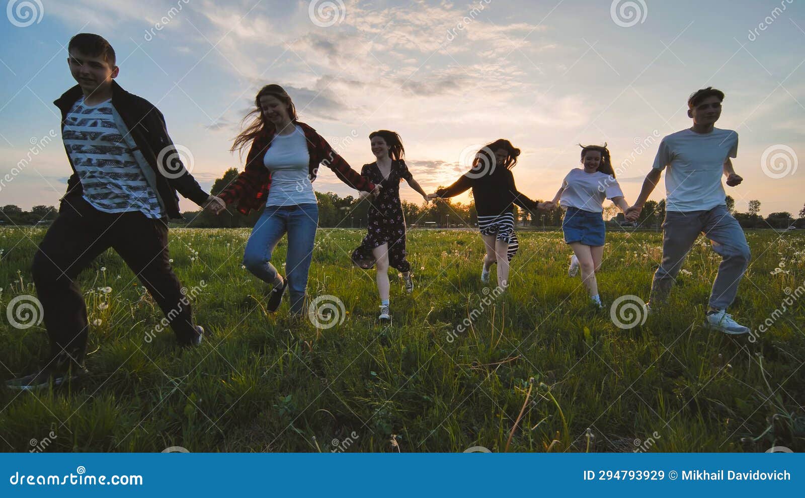 Merry Friends Run Off into the Sunset Holding Hands. Stock Image ...