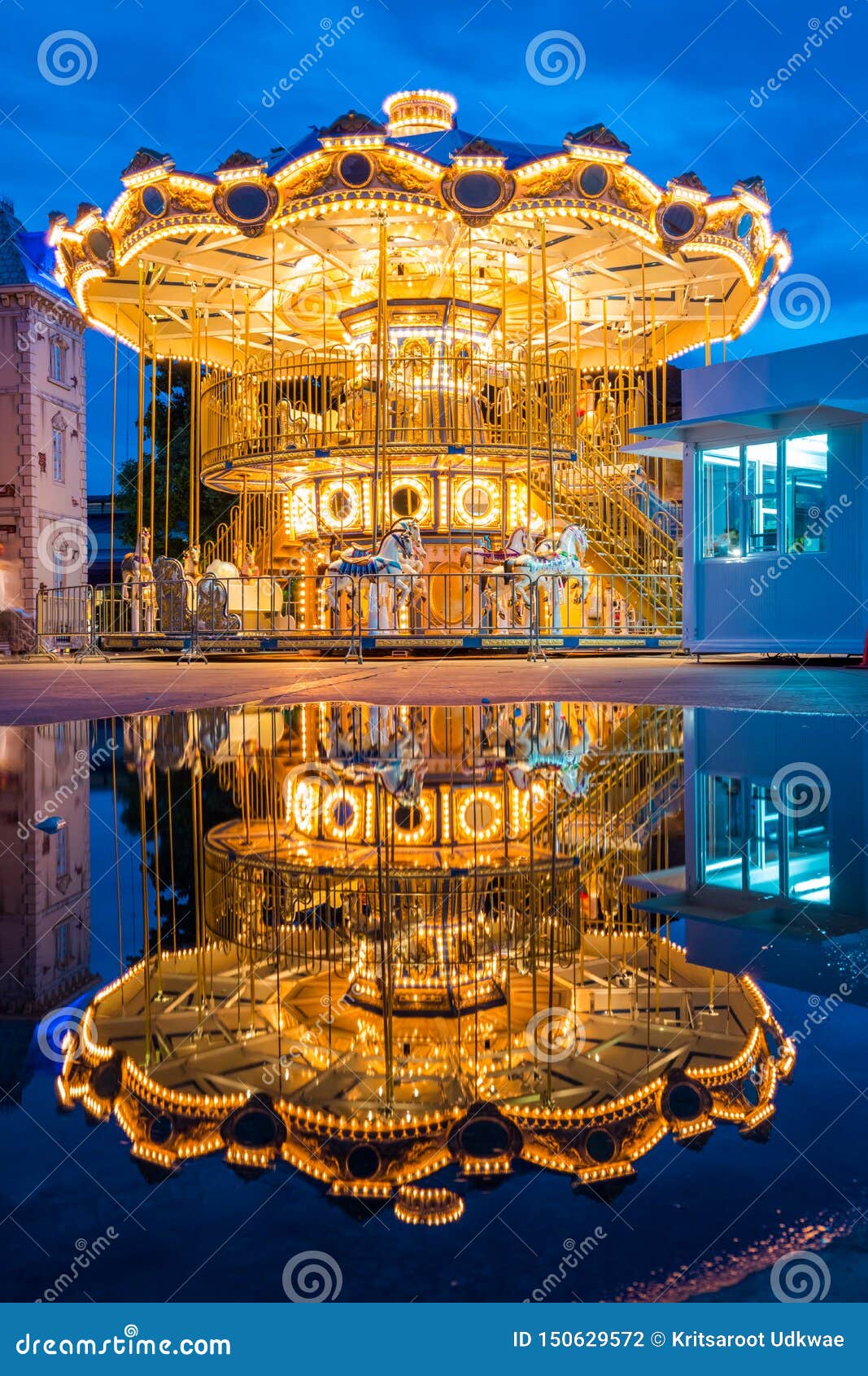 Merry Go Round at Night in Amusement Park with Reflection. Editorial ...