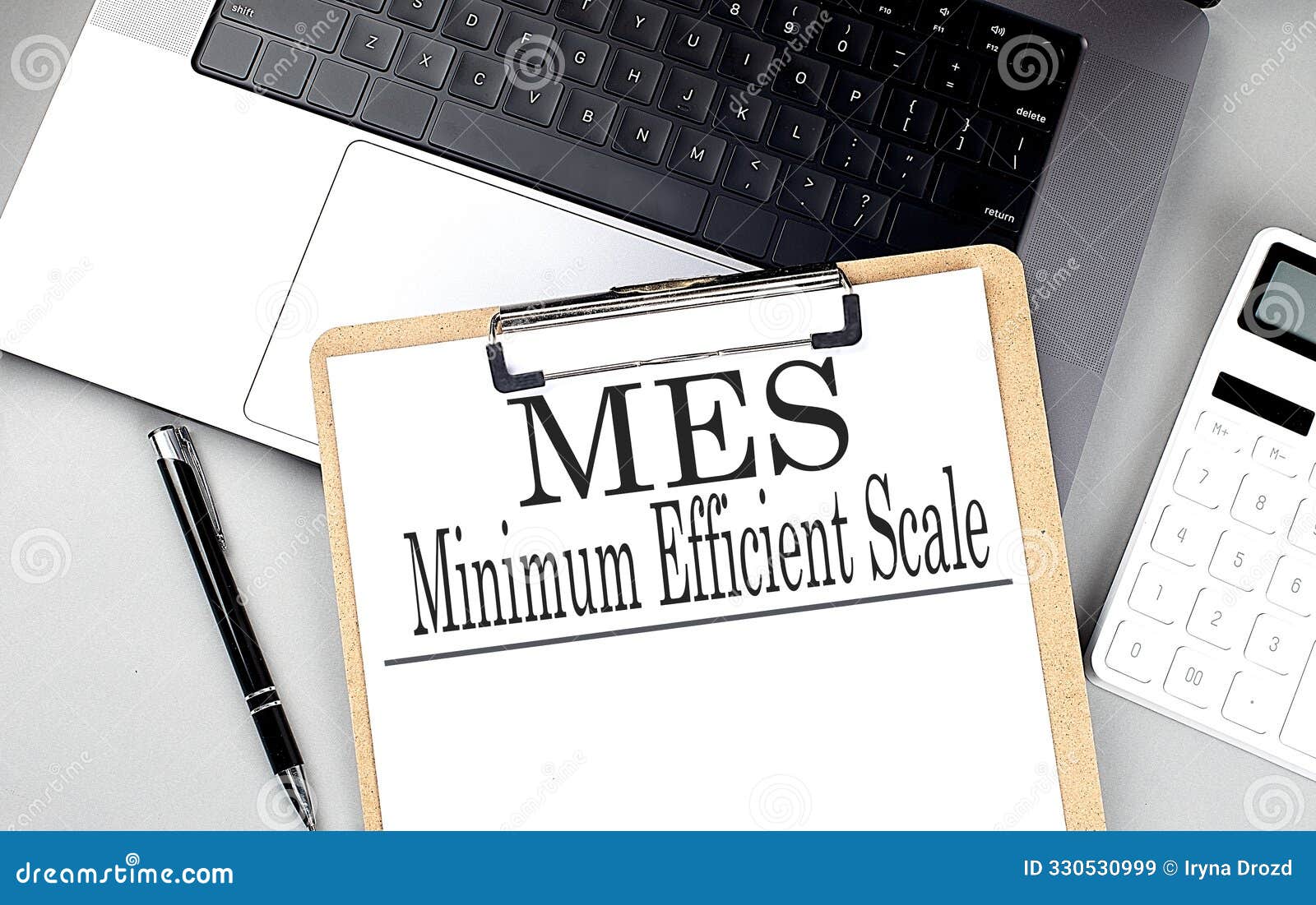 MES Minimum Efficient Scale Written on Clipboard with Laptop and ...