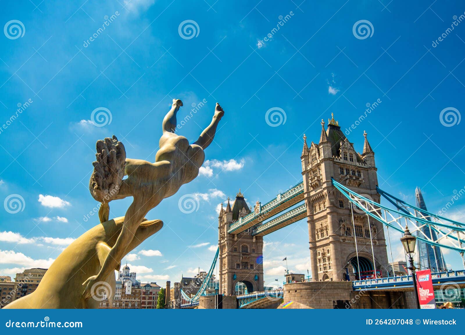 Mesmerizing Sculpture of a Man and a Dolphin with the Tower Bridge in ...
