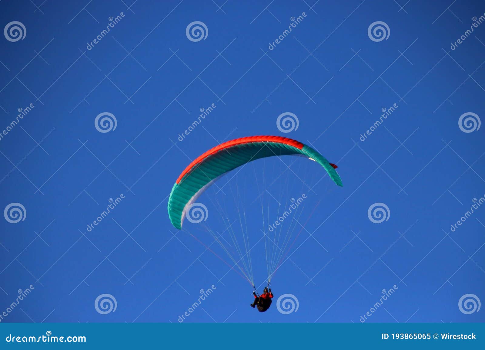 Mesmerizing Shot of a Male Flying with a Parachute High in the Sky ...