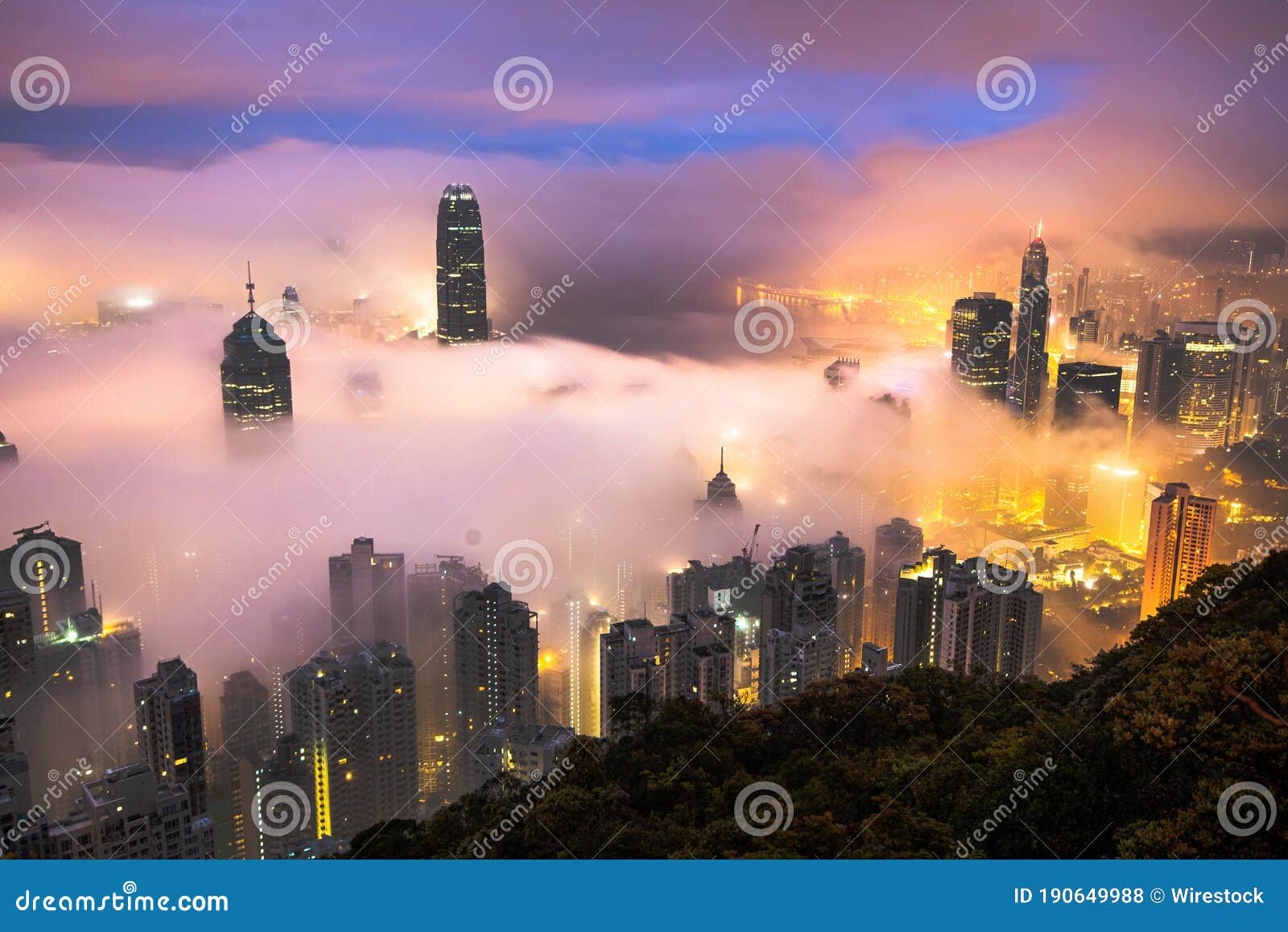 Mesmerizing Shot of the Skyscrapers of a City Covered in Mist at Night ...