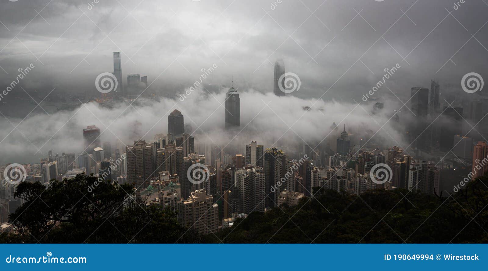 Mesmerizing Shot of the Skyscrapers of a City Covered in Mist at Night ...
