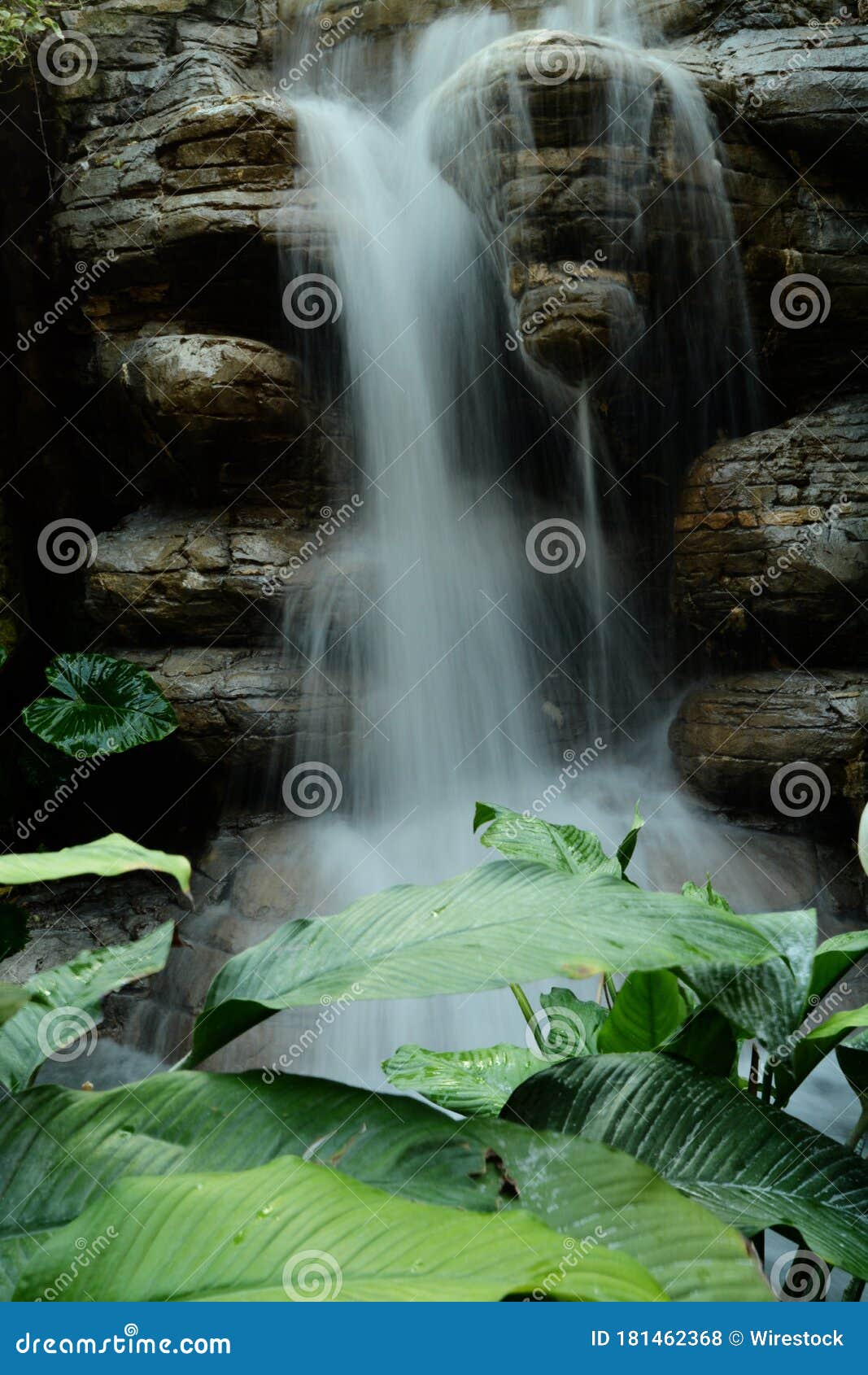 Mesmerizing Vertical Picture of a Waterfall Flowing Splashing To the ...