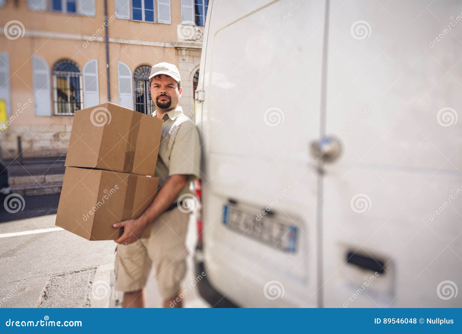 Messenger Delivering Parcel, Standing Next To His Van Stock Photo ...