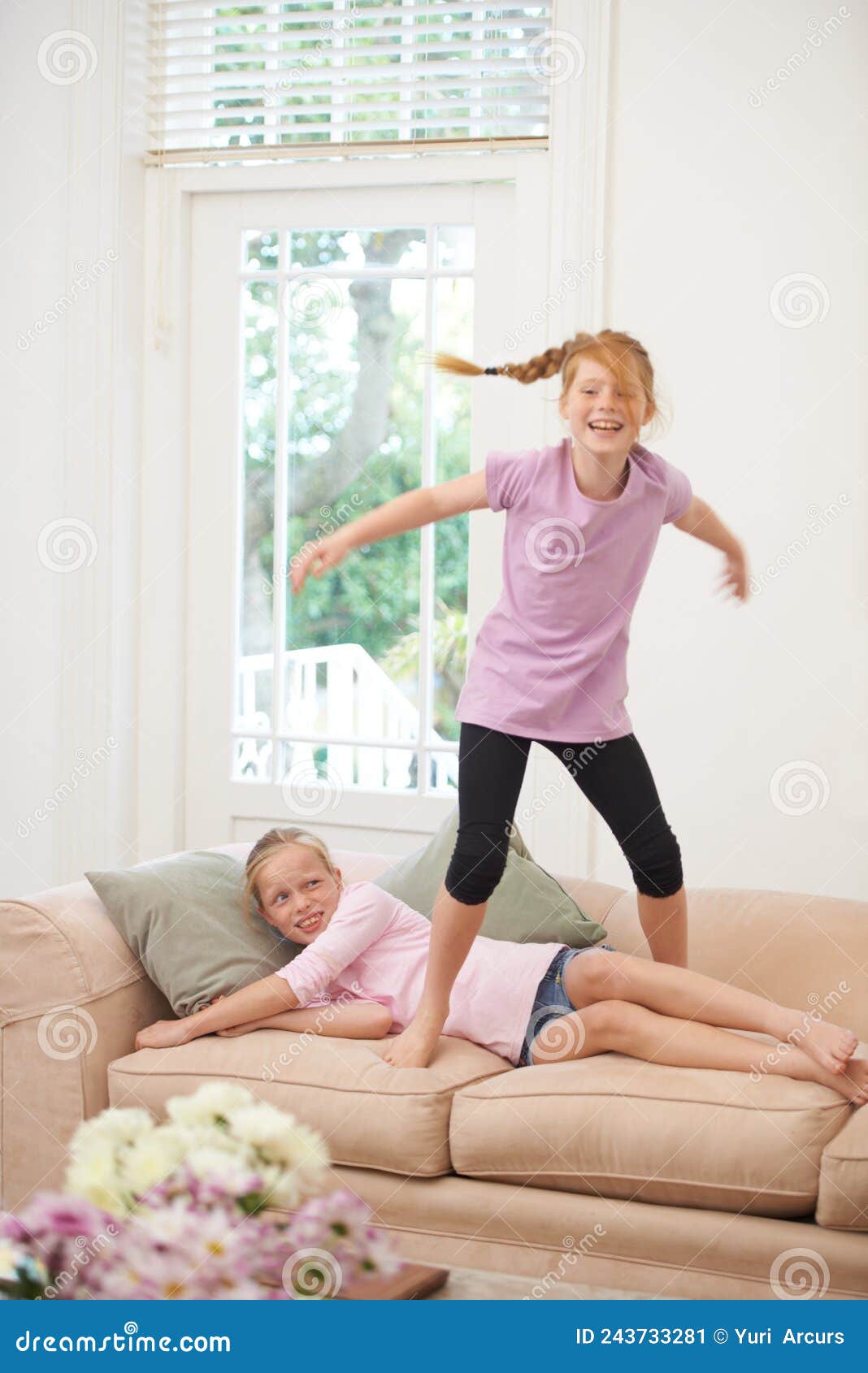Messing Around on the Couch. Two Sisters Playing on the Couch. Stock ...