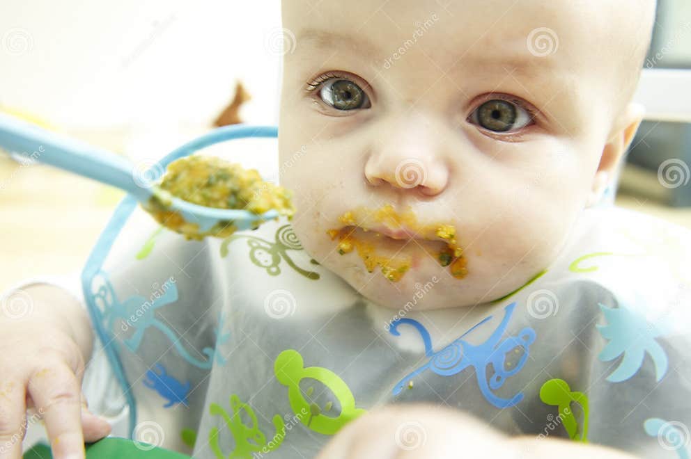 Messy Baby Being Fed stock image. Image of feeding, camera - 12021291