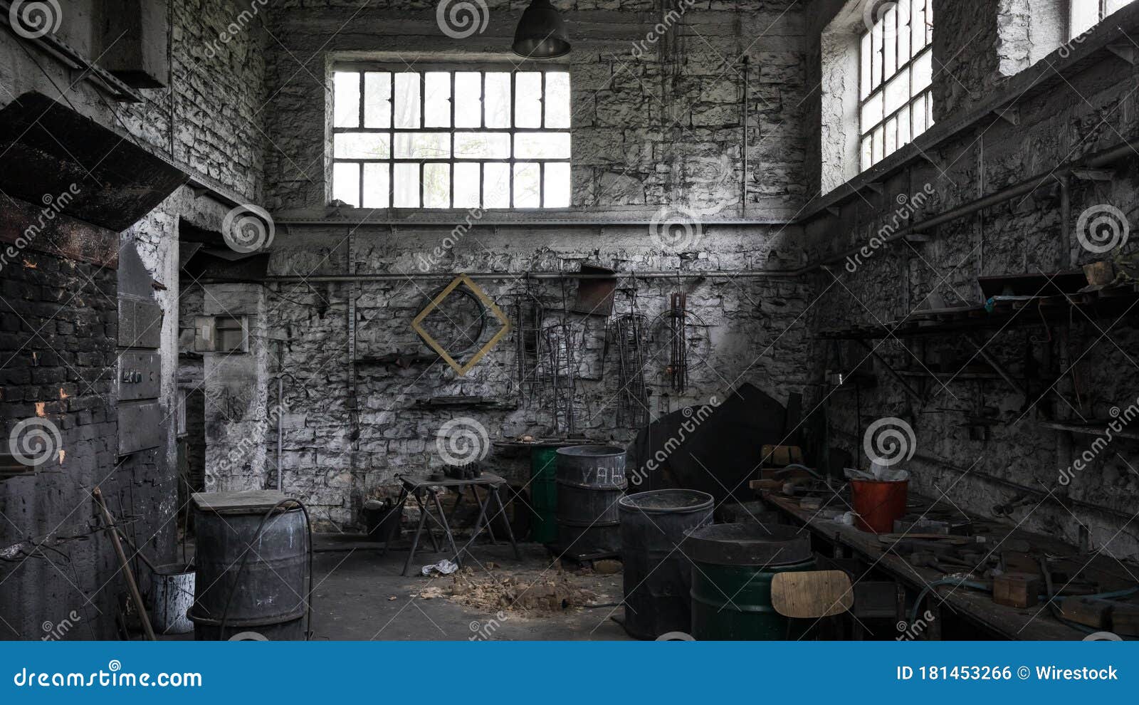 Messy Building with Metal Barrels and a Concrete Brick Wall Stock Photo ...
