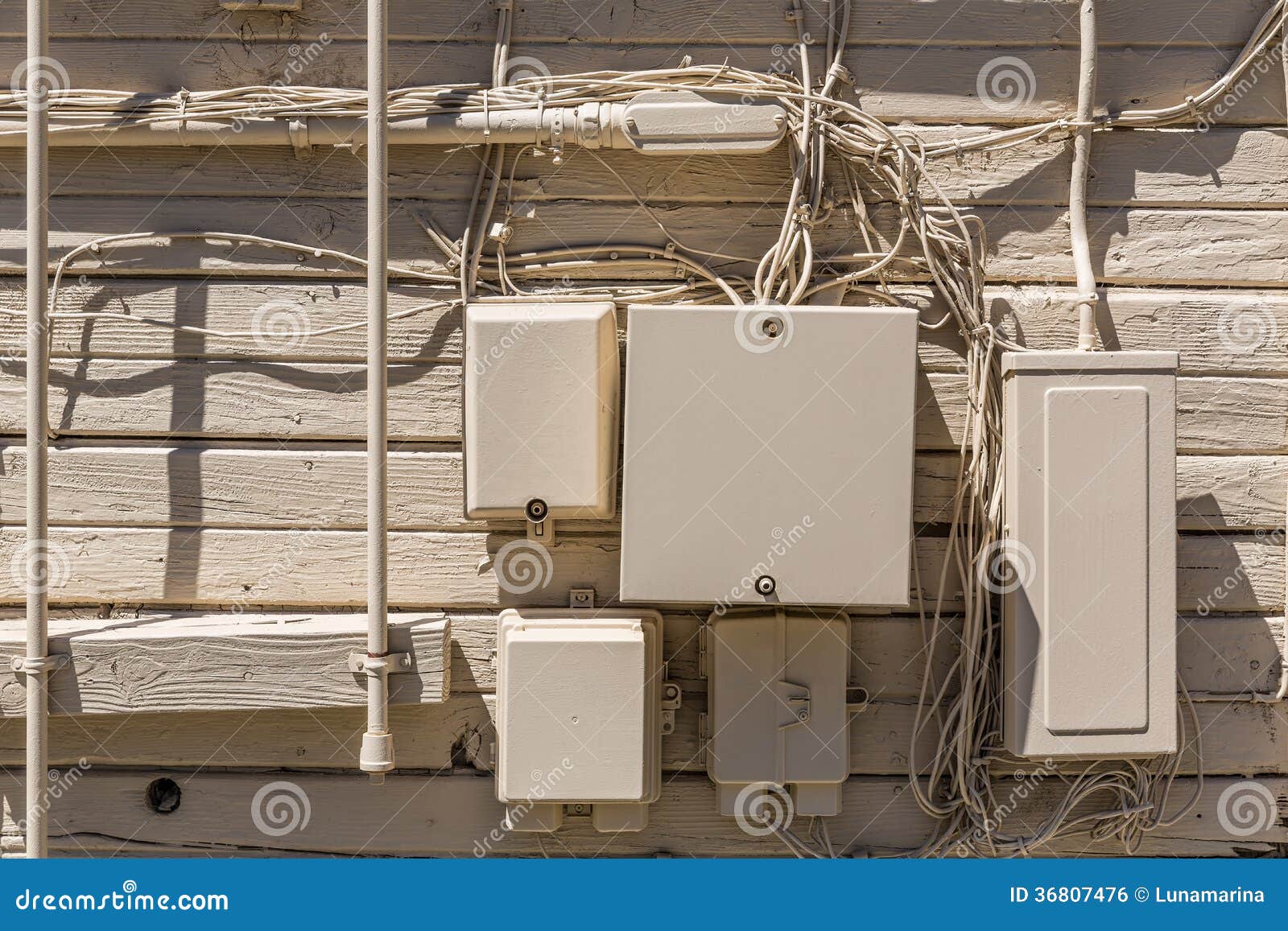 Messy Cables and Electrical Boxes in a Wooden Beige Wall Stock Photo ...