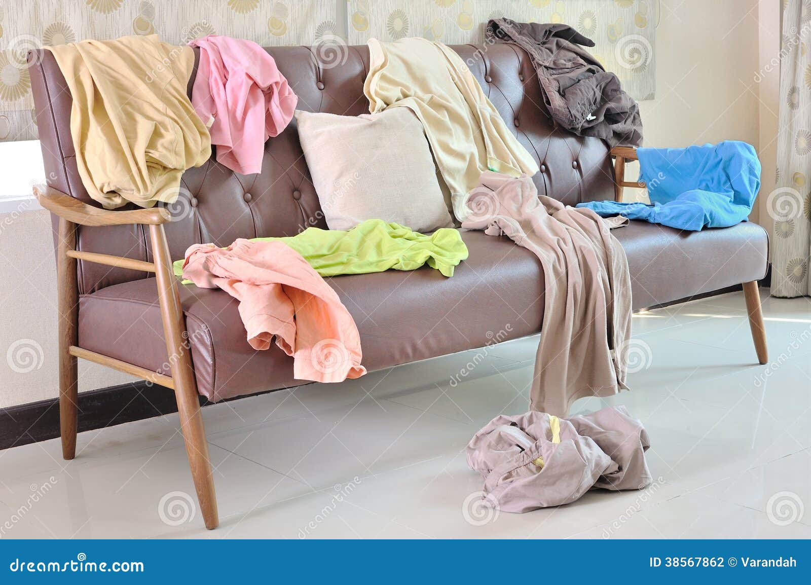 Messy Clothes Scattered on a Sofa in Room Stock Photo - Image of room ...
