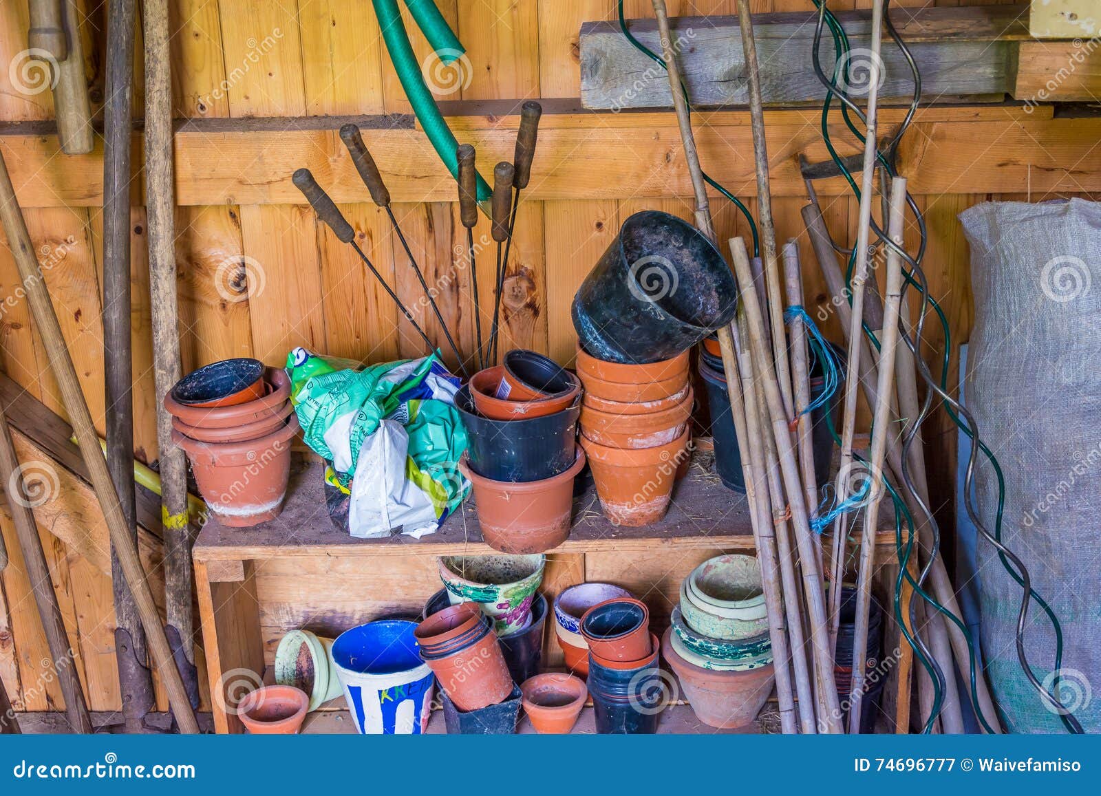 Messy Gardening Tools in Tool Shed Stacked on Shelf Stock Image - Image ...
