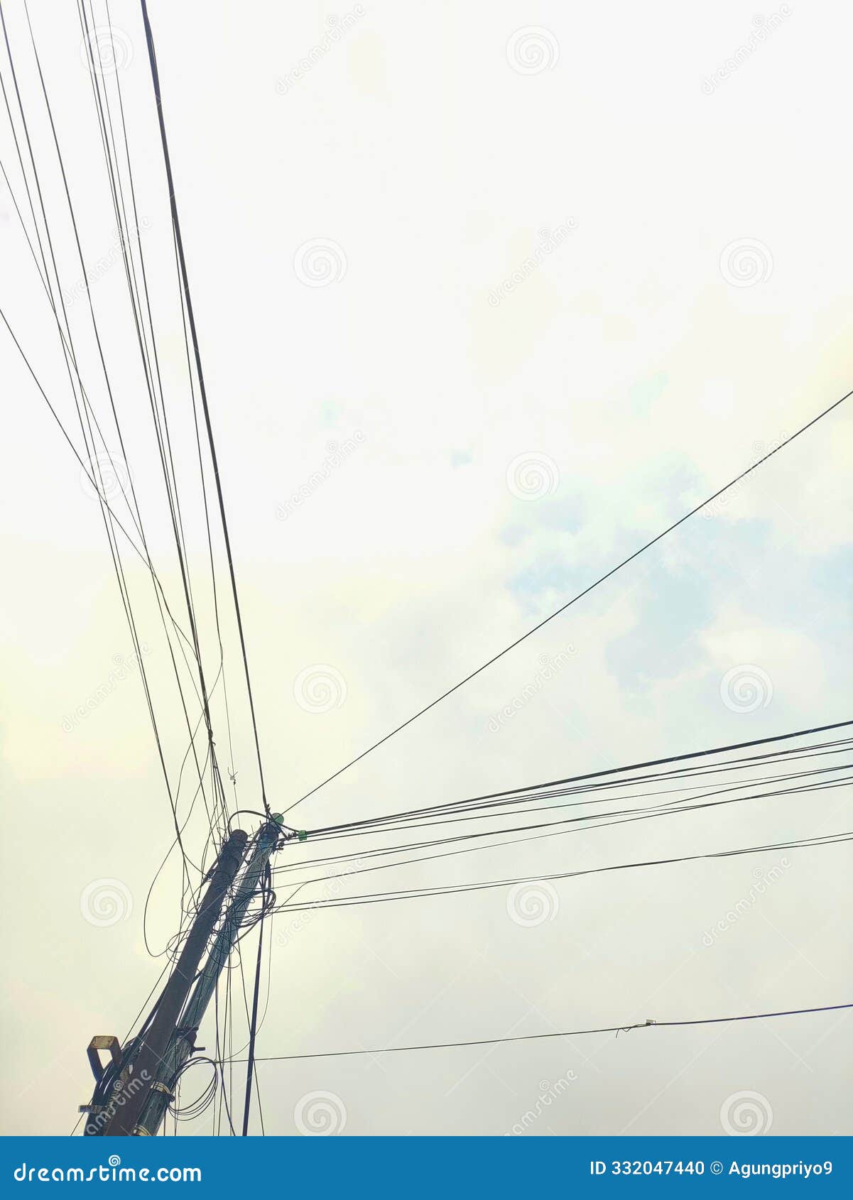 A Messy Network of Electrical Wires Against a Pale Sky Stock Photo ...