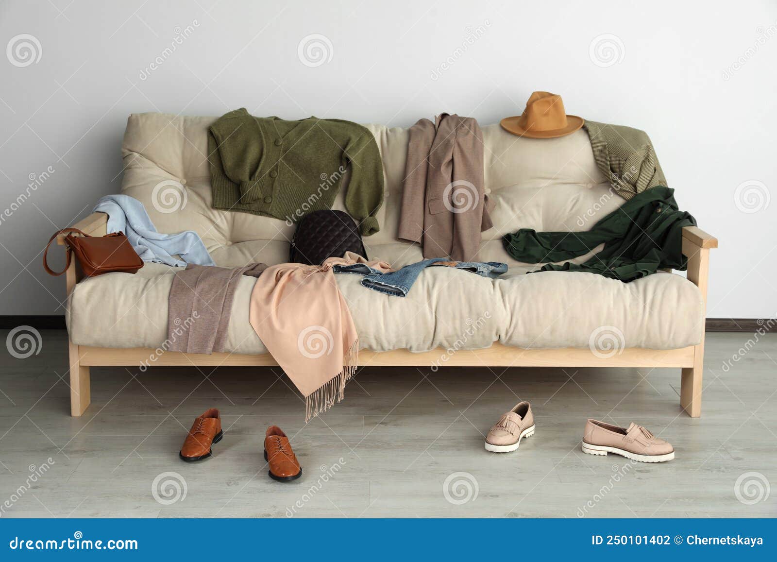 Messy Pile of Clothes and Accessories on Sofa in Living Room Stock ...