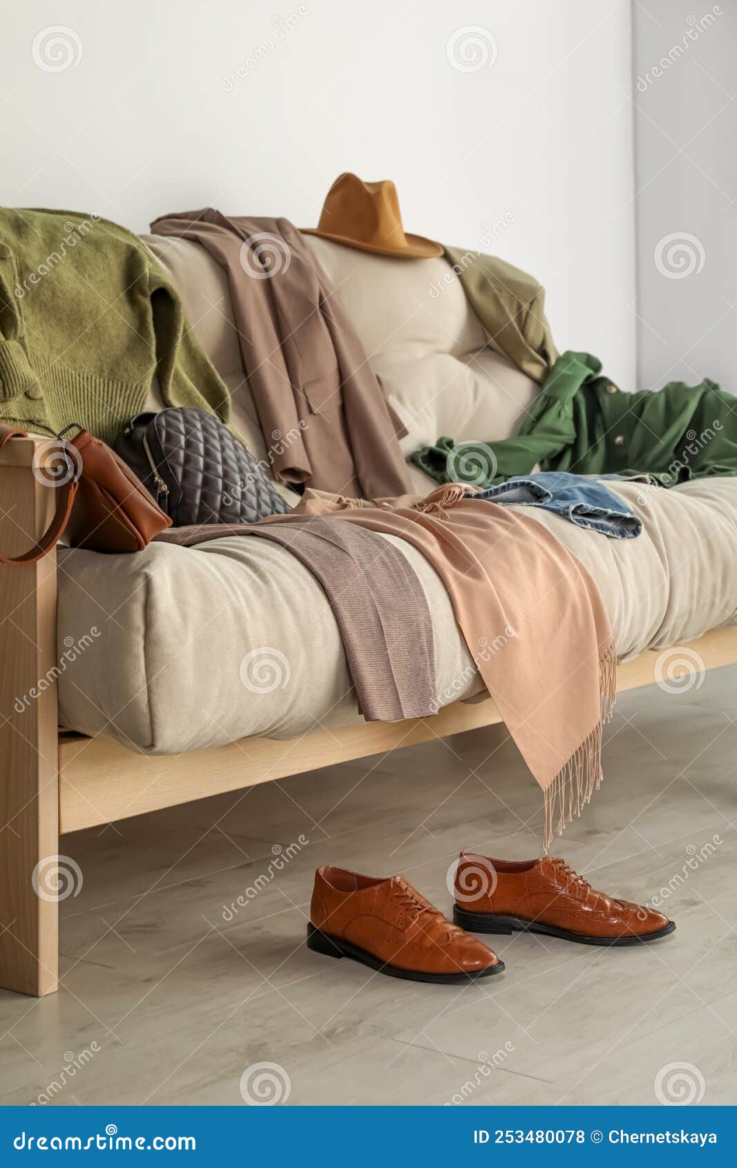 Messy Pile of Clothes and Accessories on Sofa in Living Room Stock ...