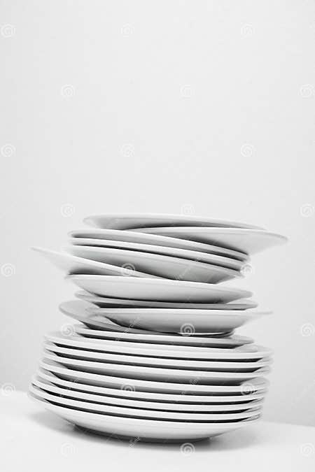 Messy Stack of White Plates about To Fall, Isolated on White Stock ...