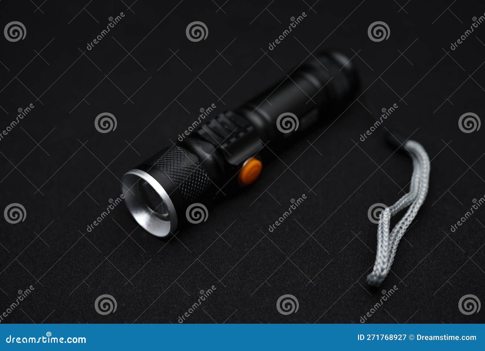 Metal Black Flashlight on a Black Background. Pocket Flashlight Stock ...