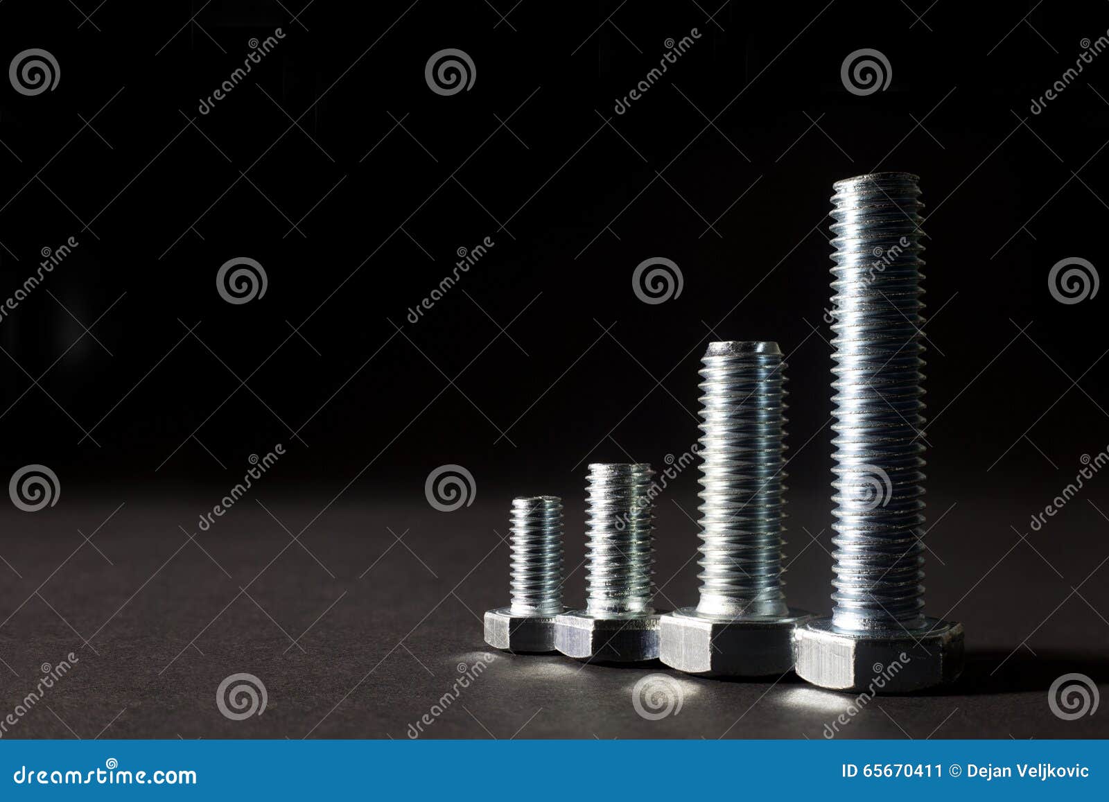 Metal Bolts Lined Up from Smallest To Largest on Black Stock Image ...
