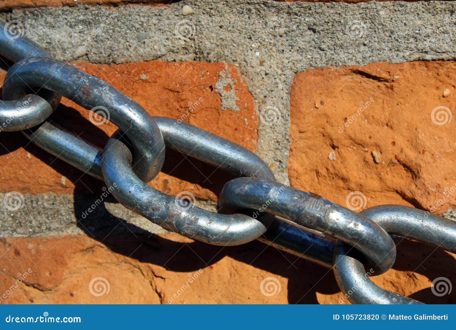 Metal Chain Lying on Terracotta Bricks Wall Stock Photo - Image of ...