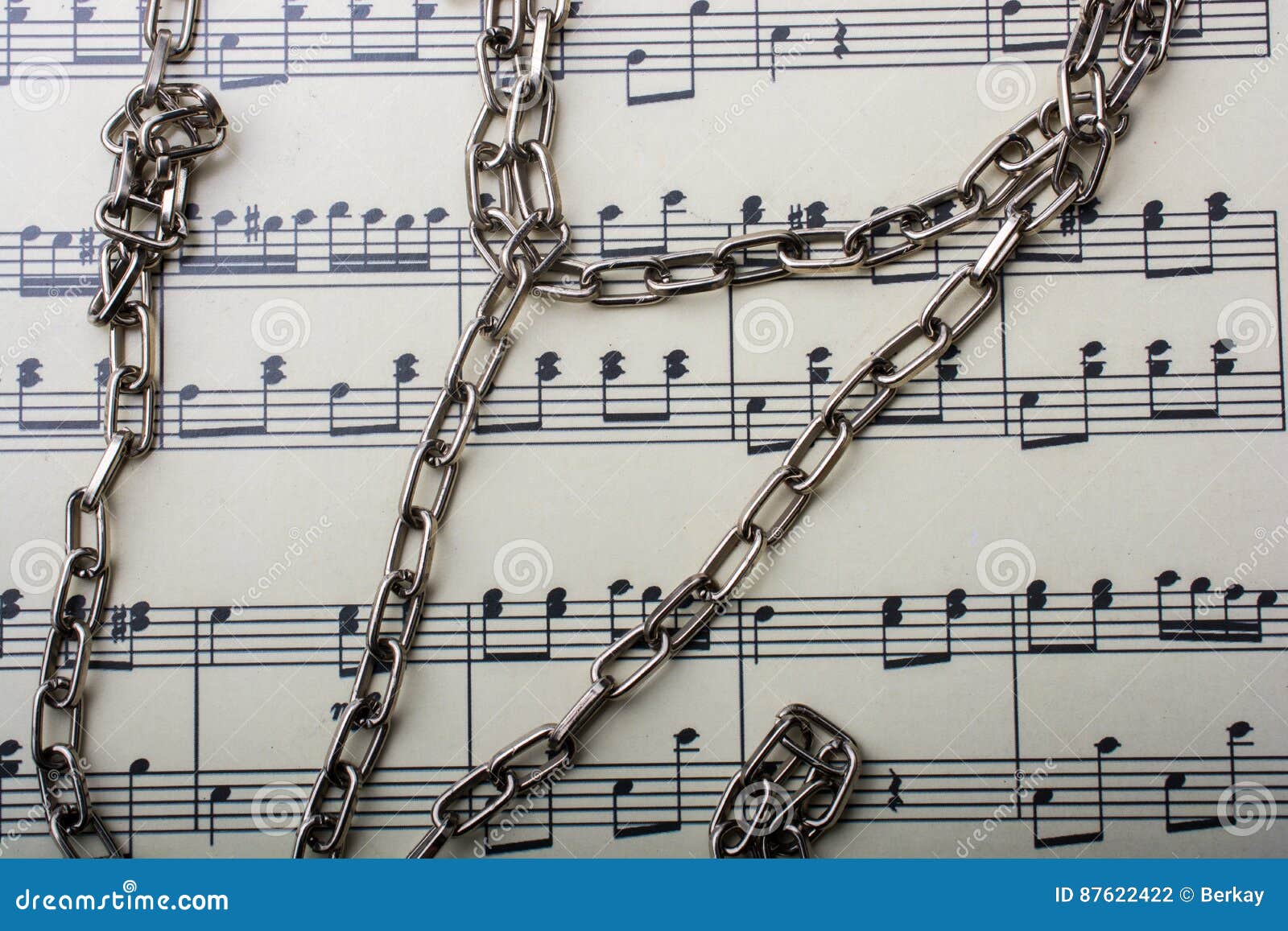 Metal Chain Placed on Paper with Musical Notes Stock Photo - Image of ...