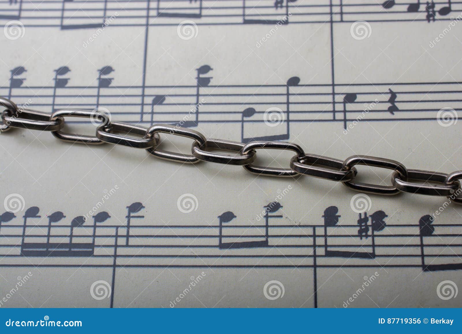 Metal Chain Placed on Paper with Musical Notes Stock Photo - Image of ...