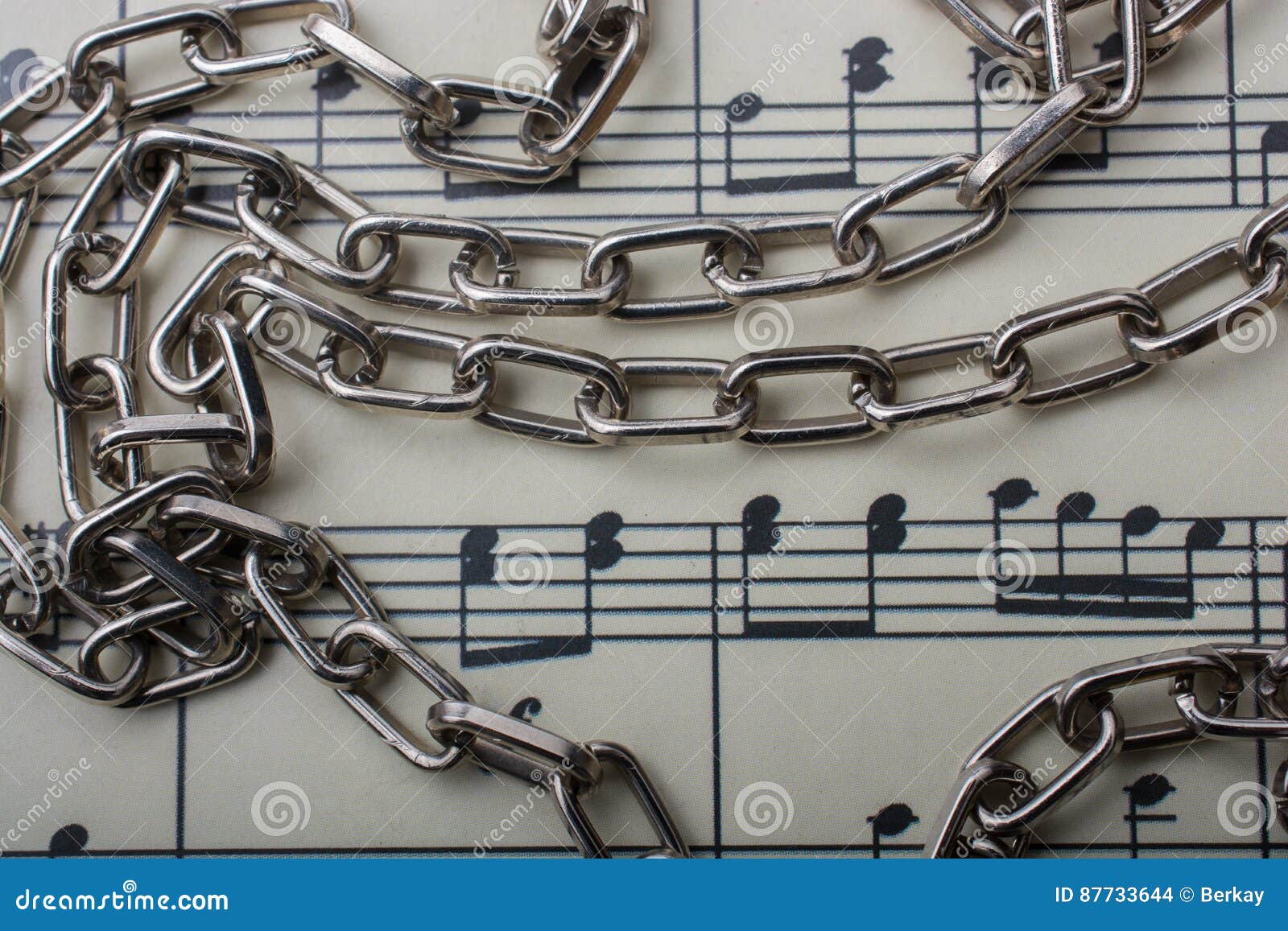 Metal Chain Placed on Paper with Musical Notes Stock Photo - Image of ...