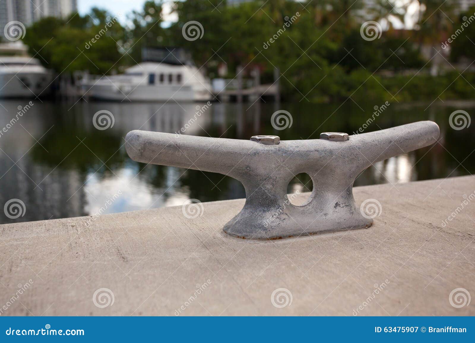 Metal Cleat For Mooring Boats, Bolted To The Ground, With Rope And ...