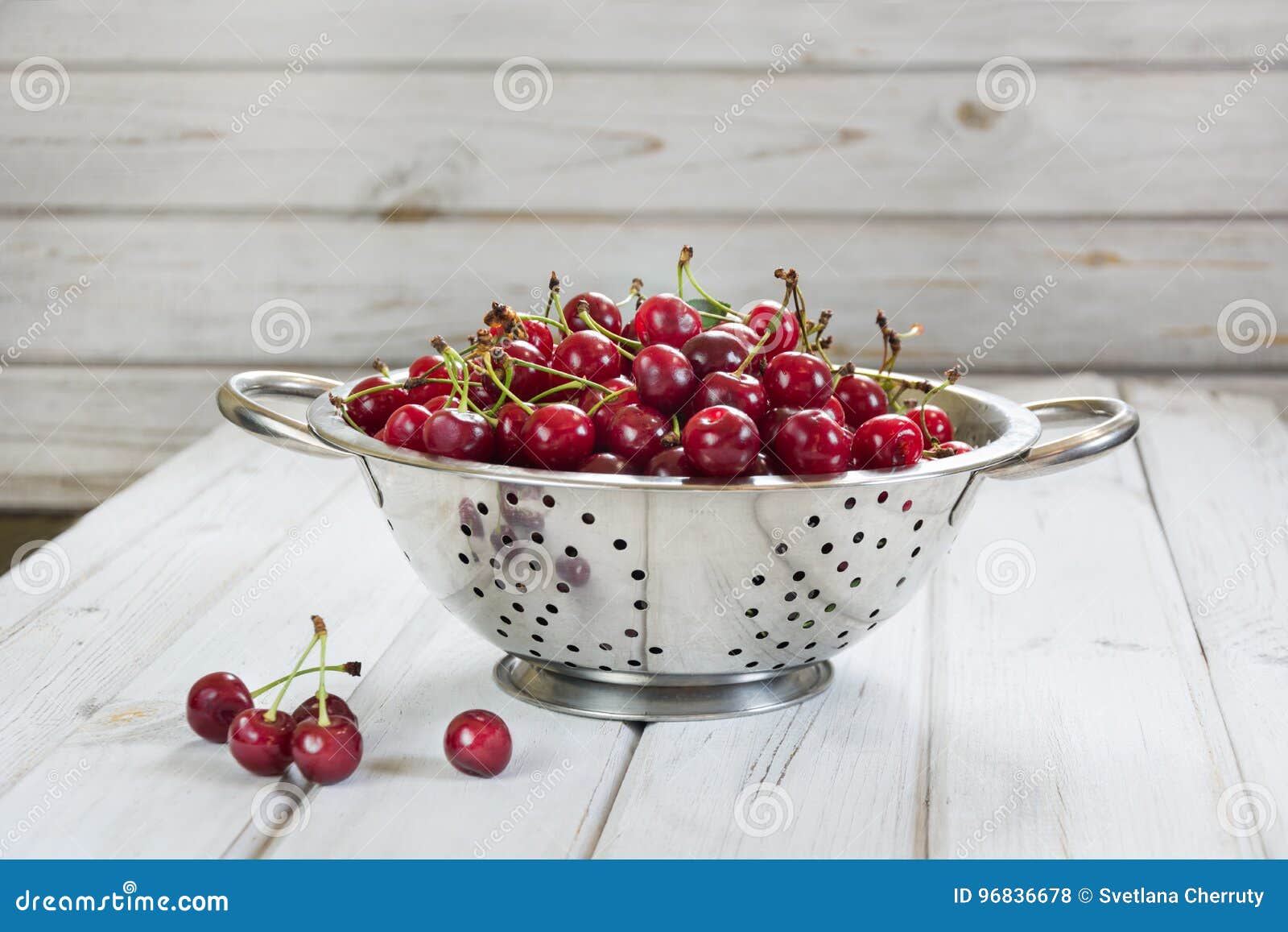 Metal Colander Full of Freshly Cherries Over a Rustic Board. Cherry ...