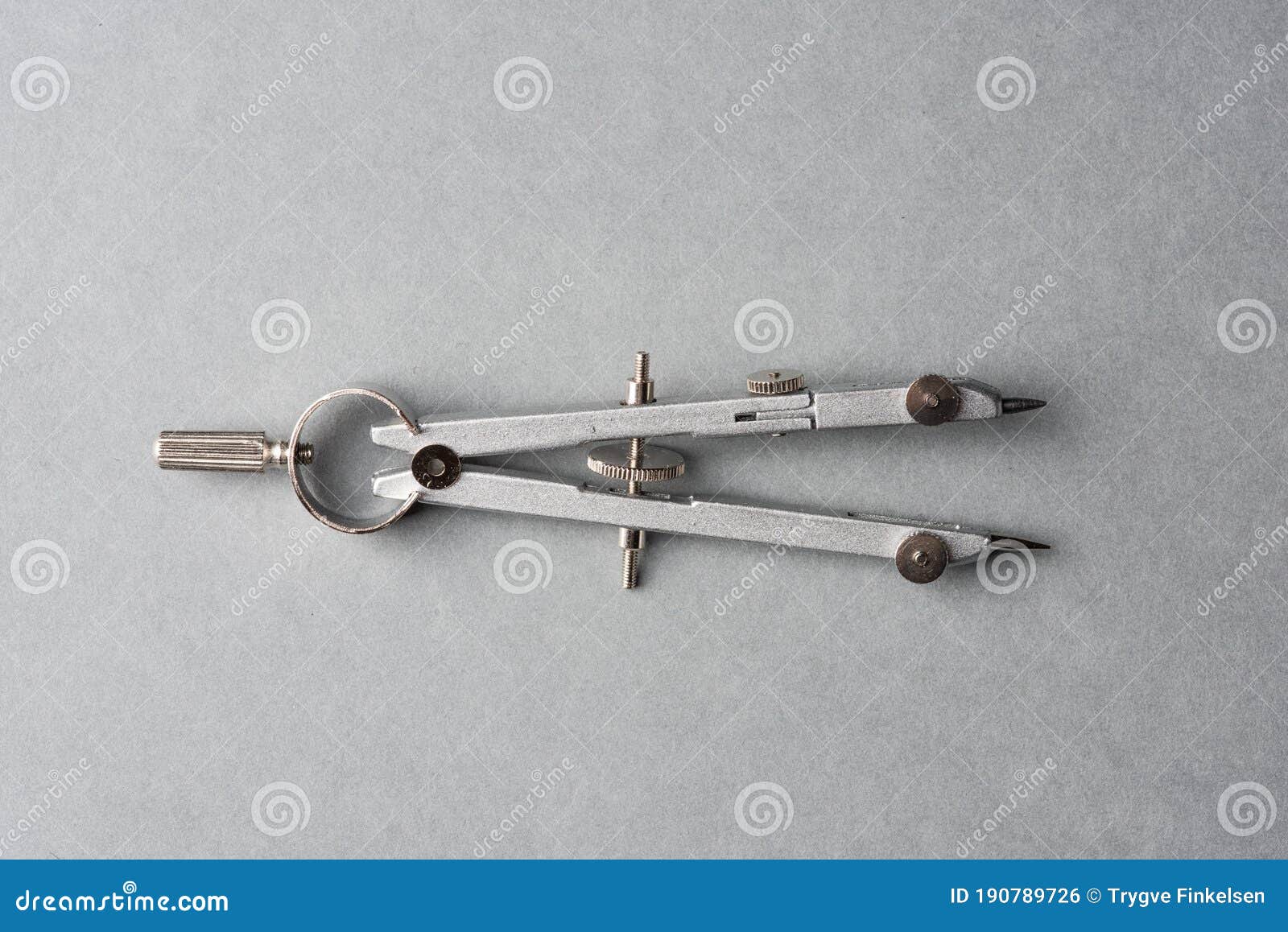 A Metal Compass on Grey Background Stock Photo - Image of black ...