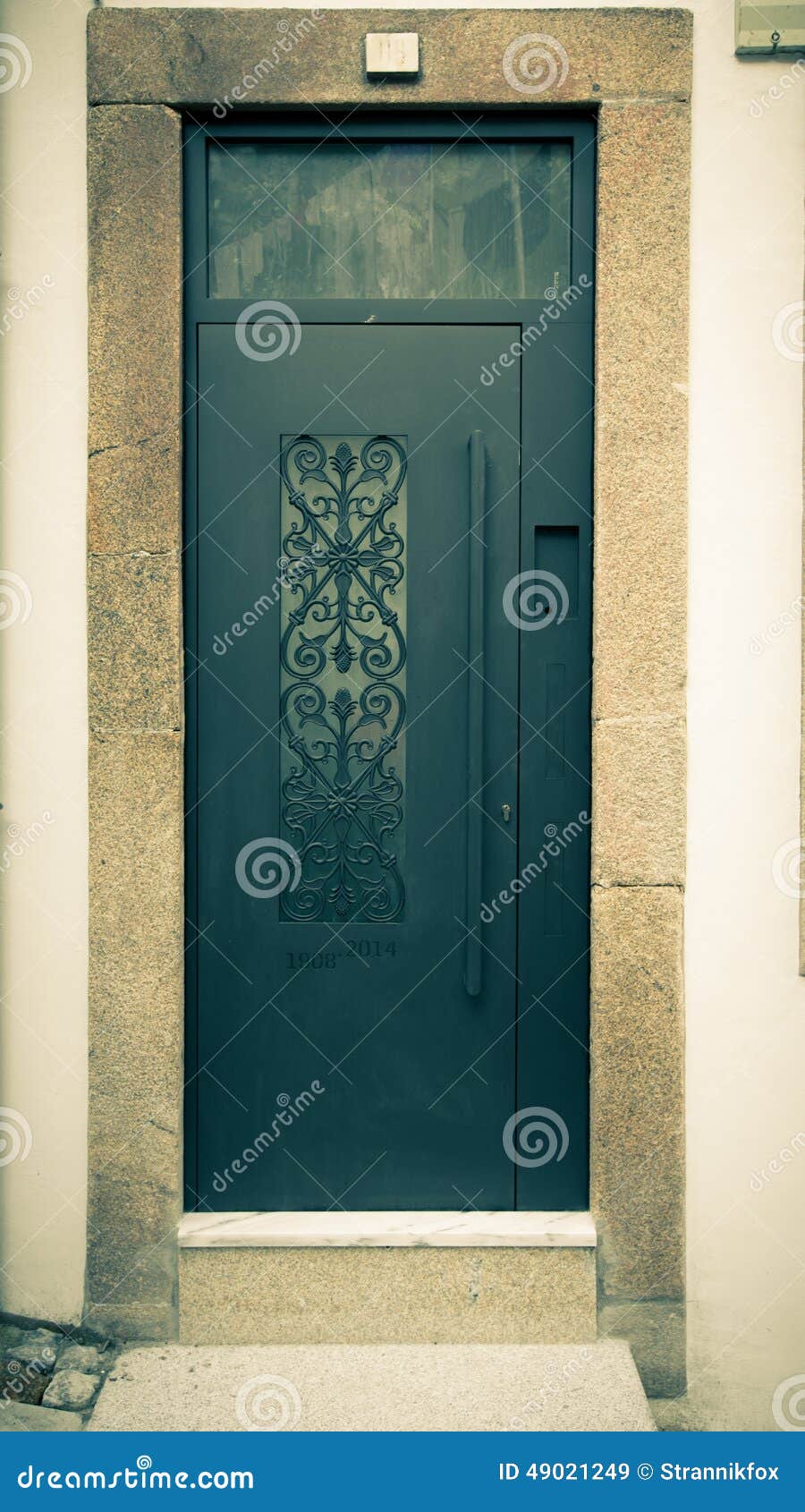 Metal Door with Patterns on the Stone Wall. Toned Stock Image - Image ...