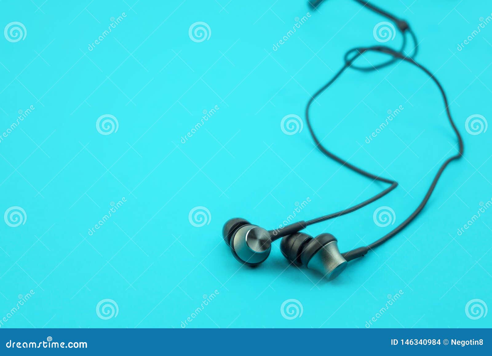 Metal Ear Buds and Wires on Blue Background, Low Angle Stock Photo ...