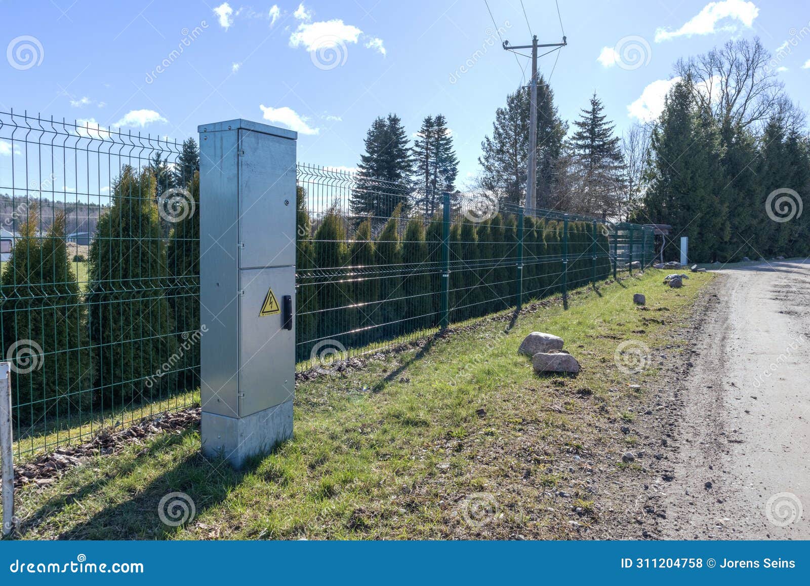 Metal Electrical Distribution Box in Front of the Fence Stock Photo ...