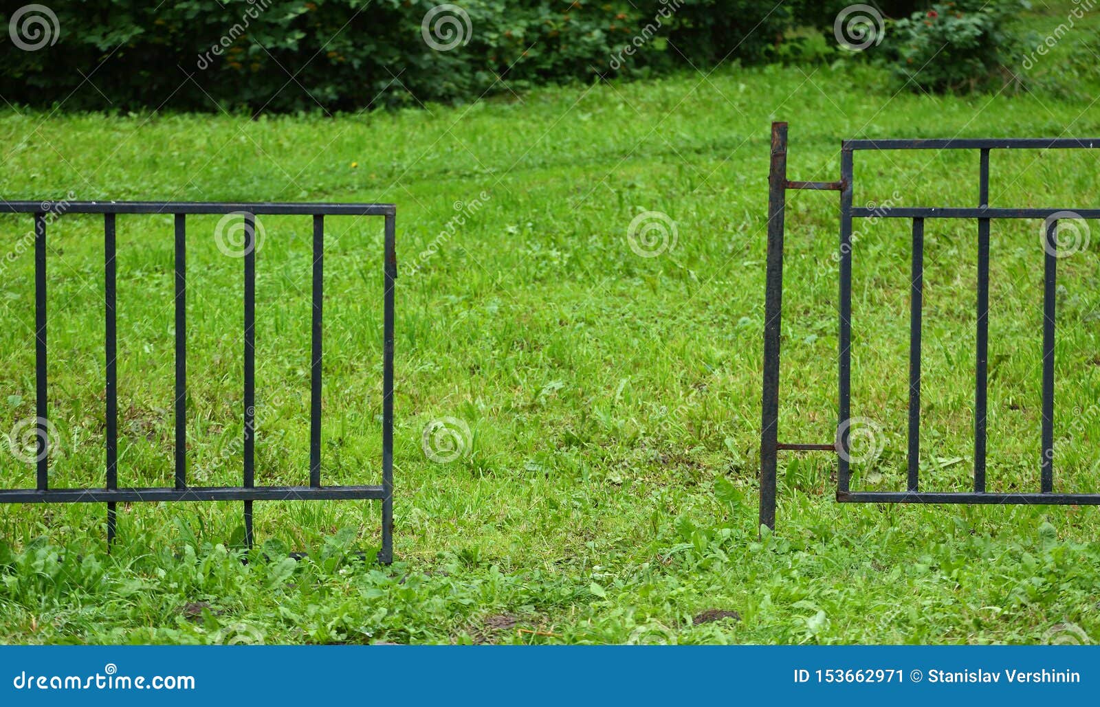 Metal Fence with a Broken Gate on the Green Grass Stock Image - Image ...
