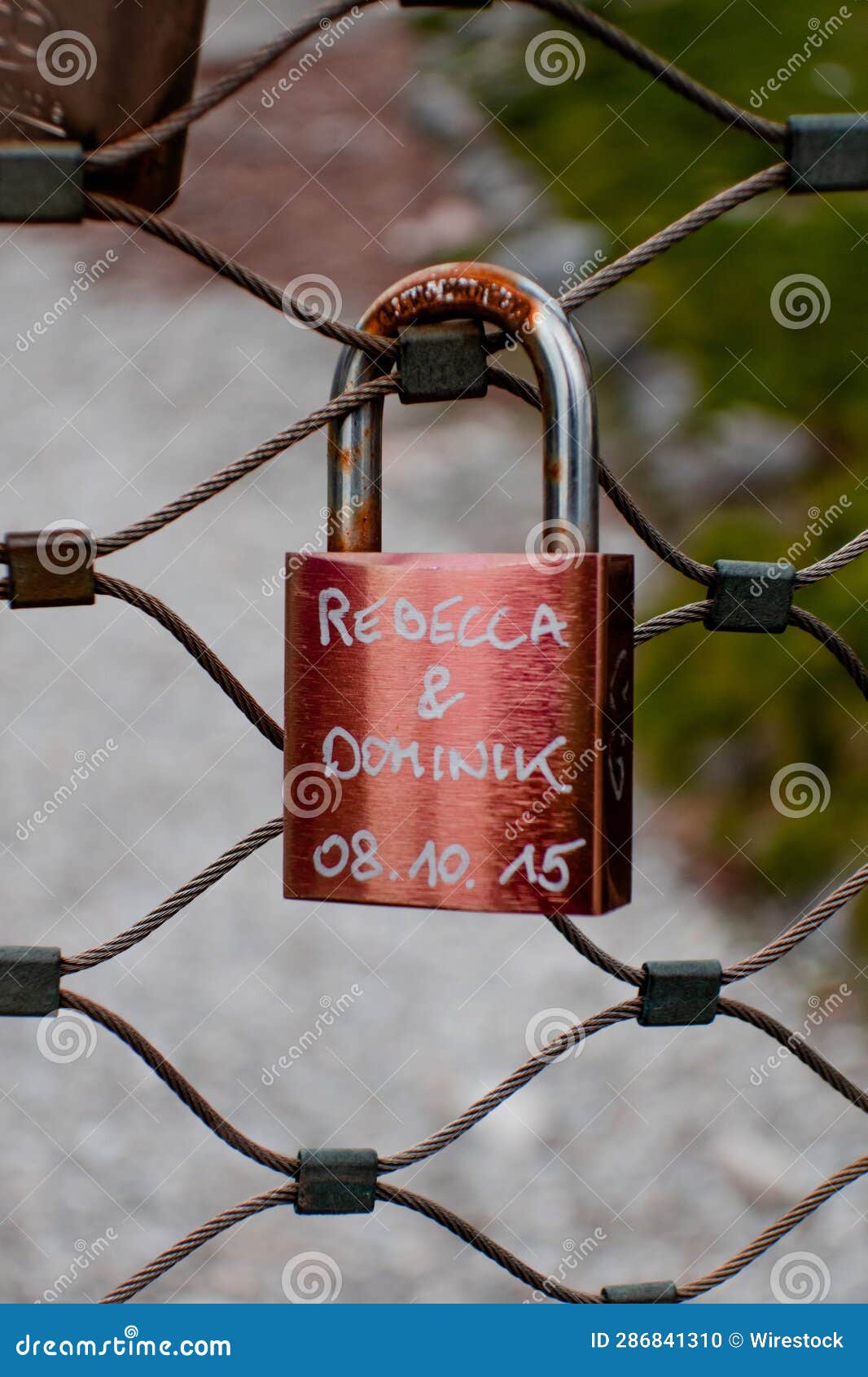 Metal Fence with a Lock Secured To it with Writing on it Stock Photo ...