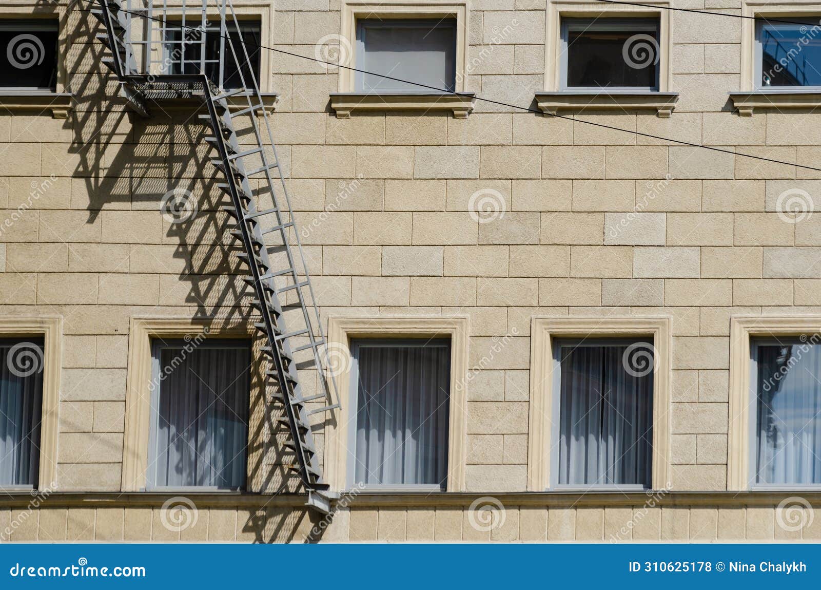 Metal Fire Safety Ladder on the Facade of the Building. Stock Photo ...