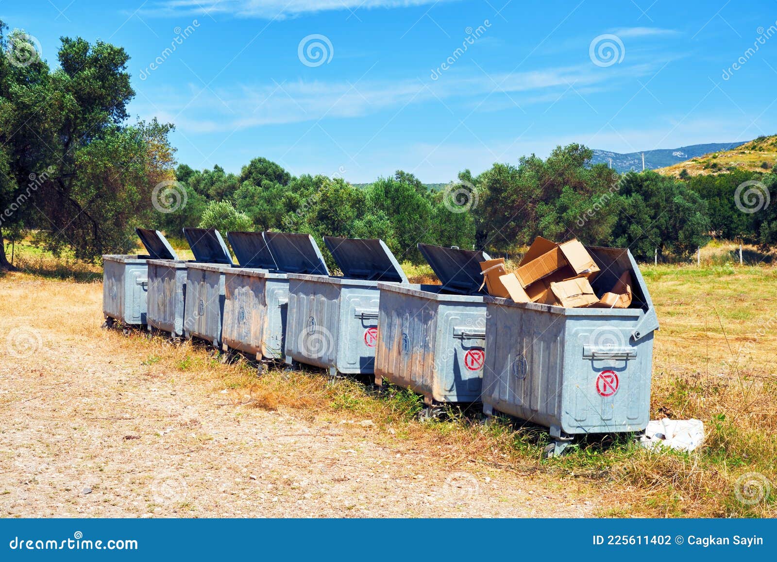 Metal Garbage Containers in a Row in a Rural Field Stock Photo - Image ...