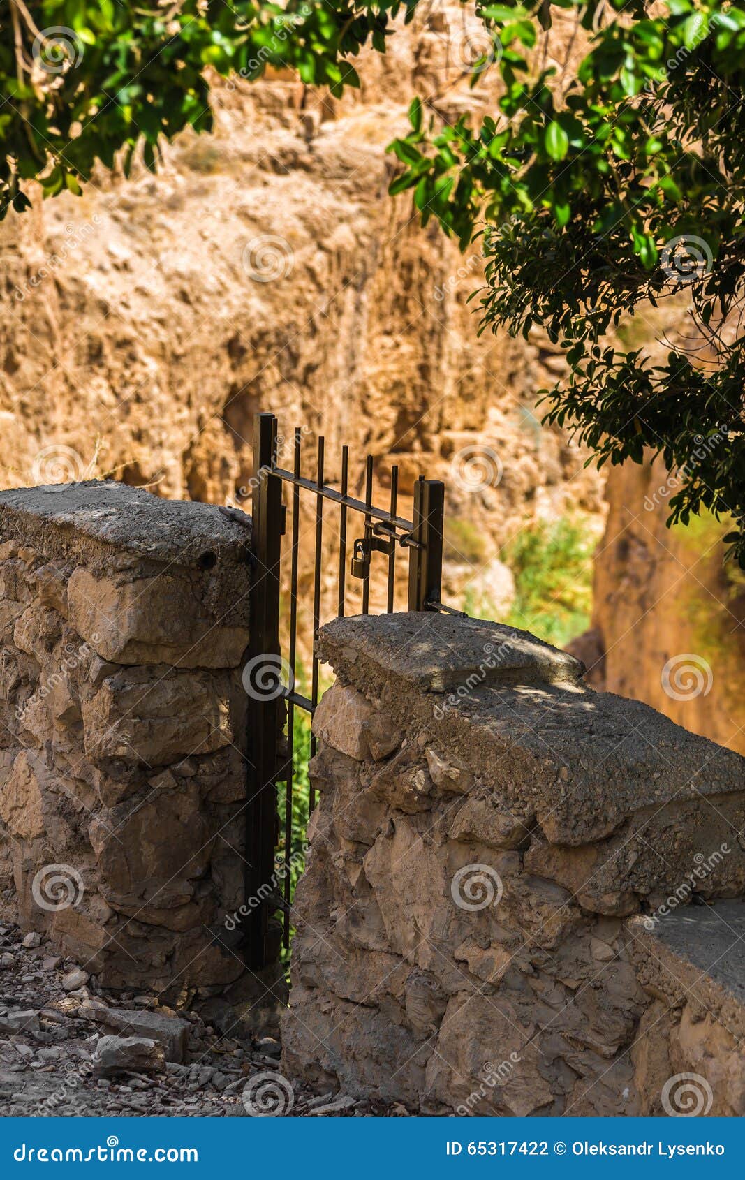 Metal gate in stone wall stock photo. Image of architecture - 65317422