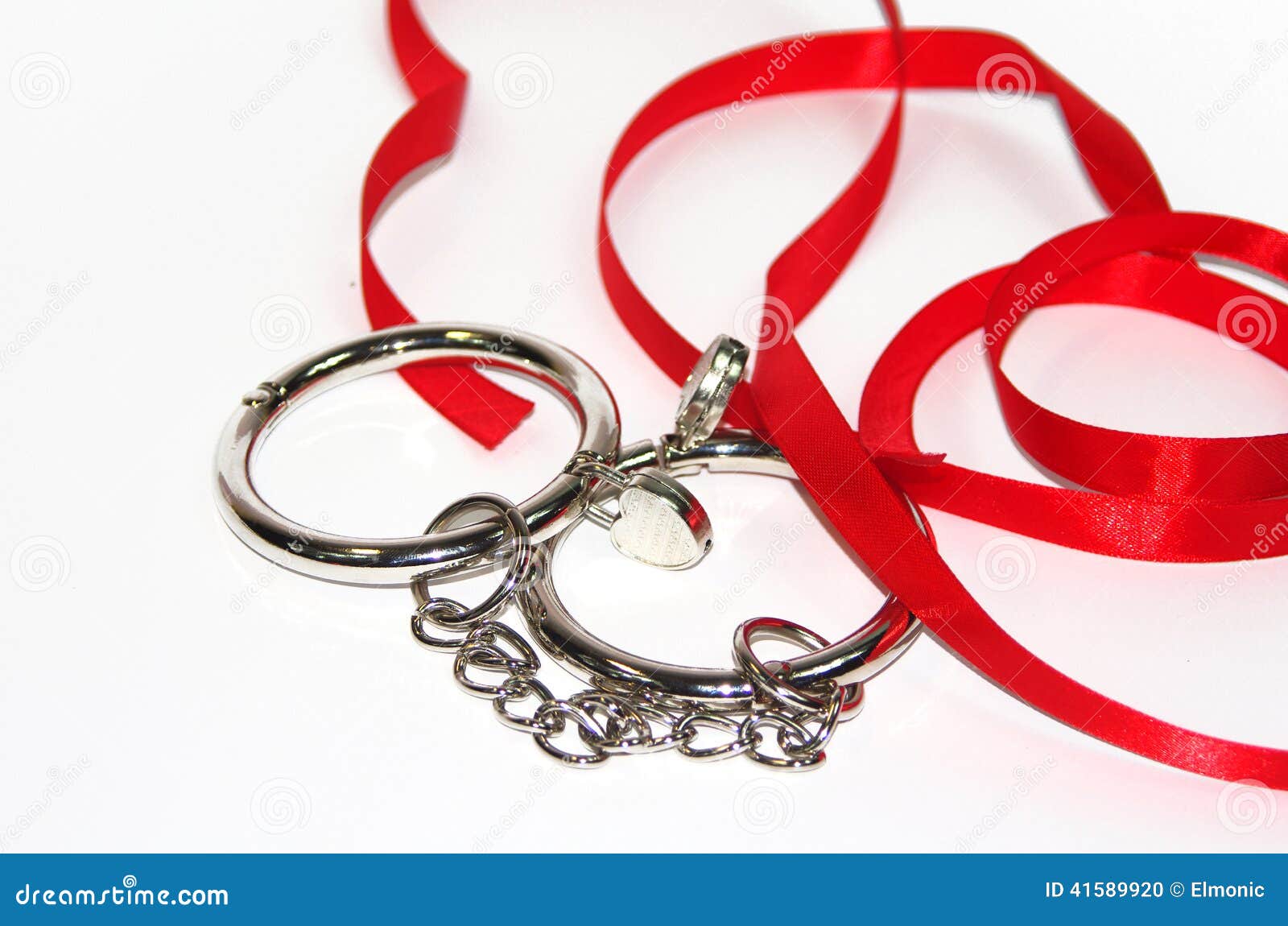 Metal Handcuffs Isolated On The White Background And Red Ribbon Stock ...