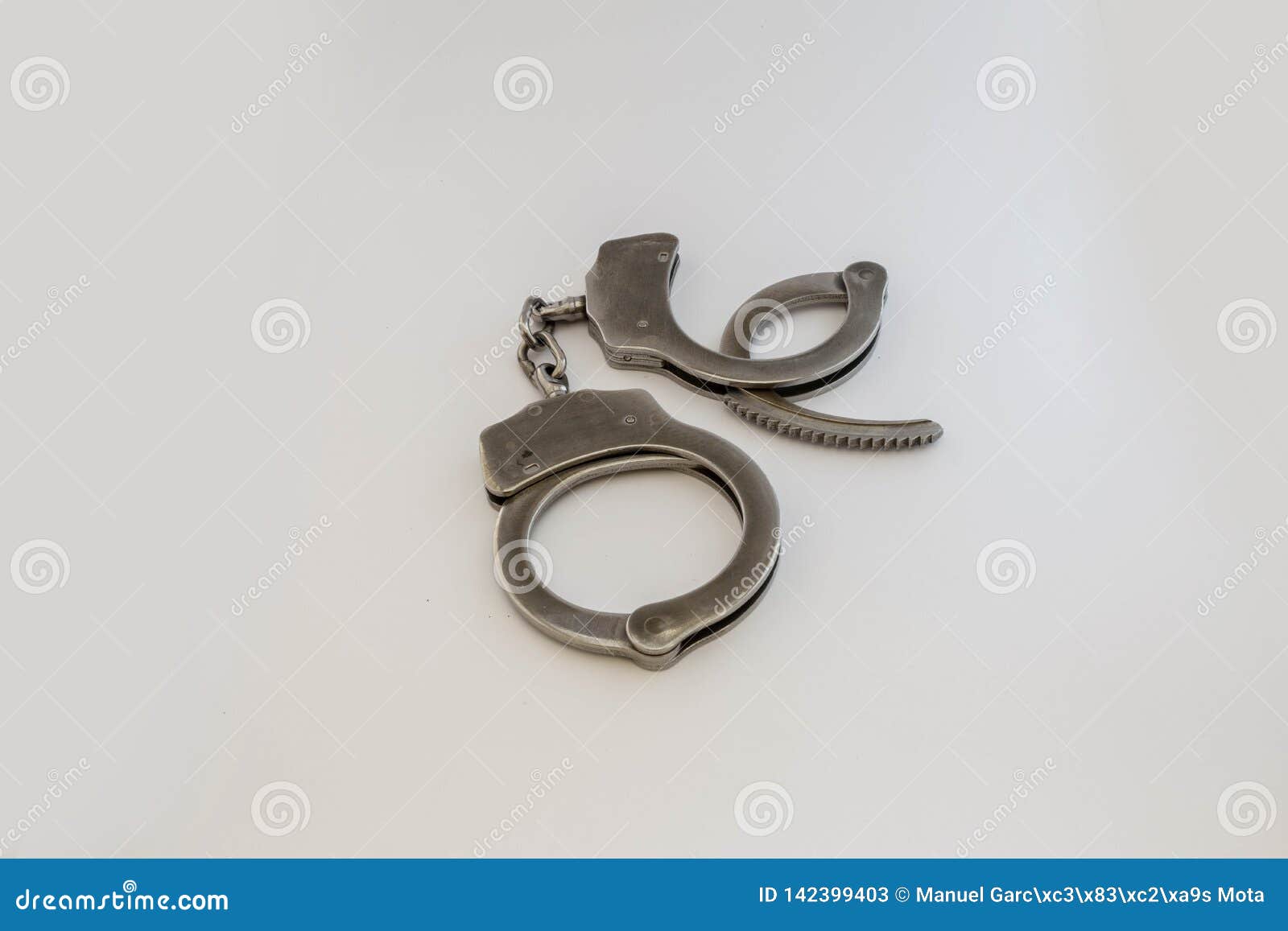 A Metal handcuffs stock image. Image of handcuff, graphic - 142399403