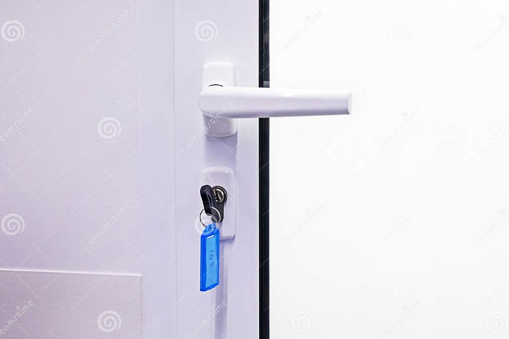 Handle on a White Closed Door with a Key Installed. Modern Interior ...