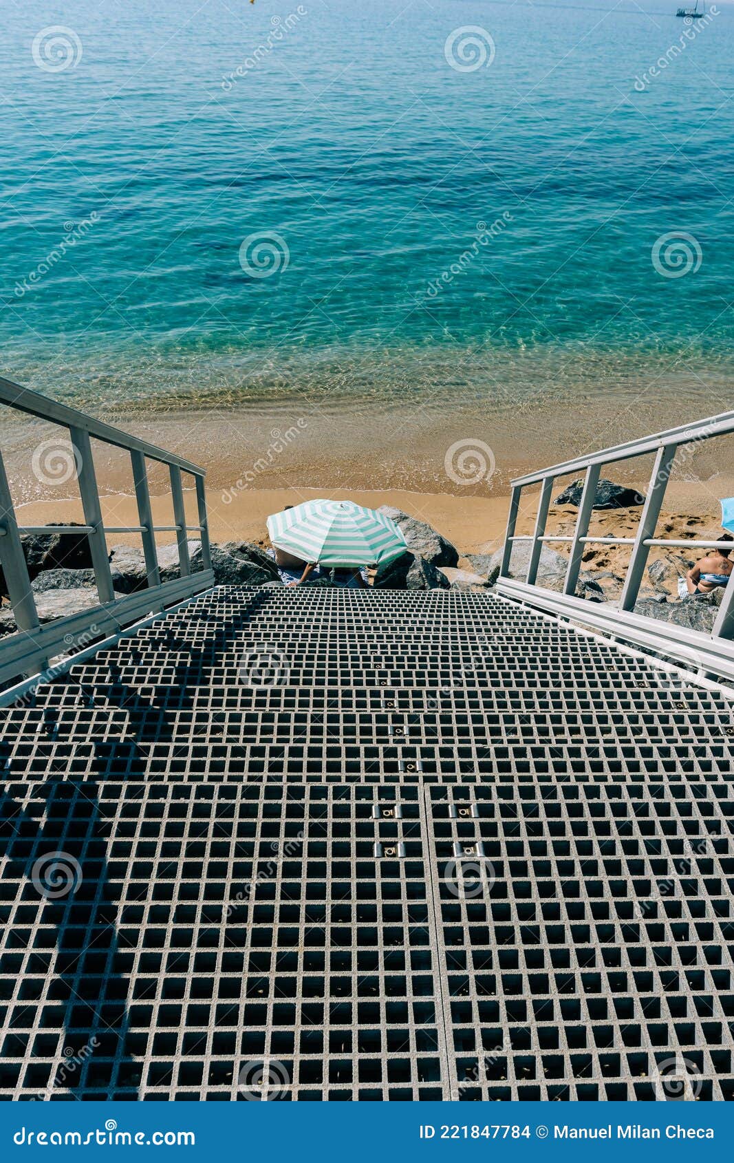 Metal Ladder To Access the Beach with an Umbrella at the End Stock ...