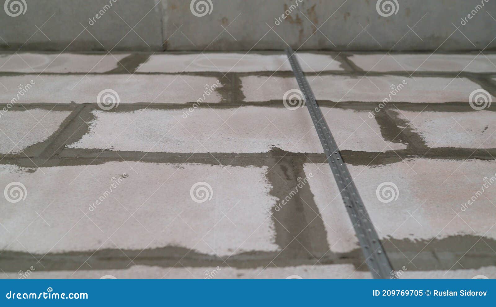 A Metal Lighthouse is Installed on a Concrete Wall. Leveling the Wall ...