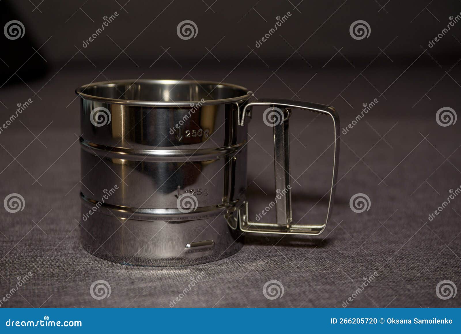 Metal Measuring Cup with a Sifter for Flour on a Gray Background ...