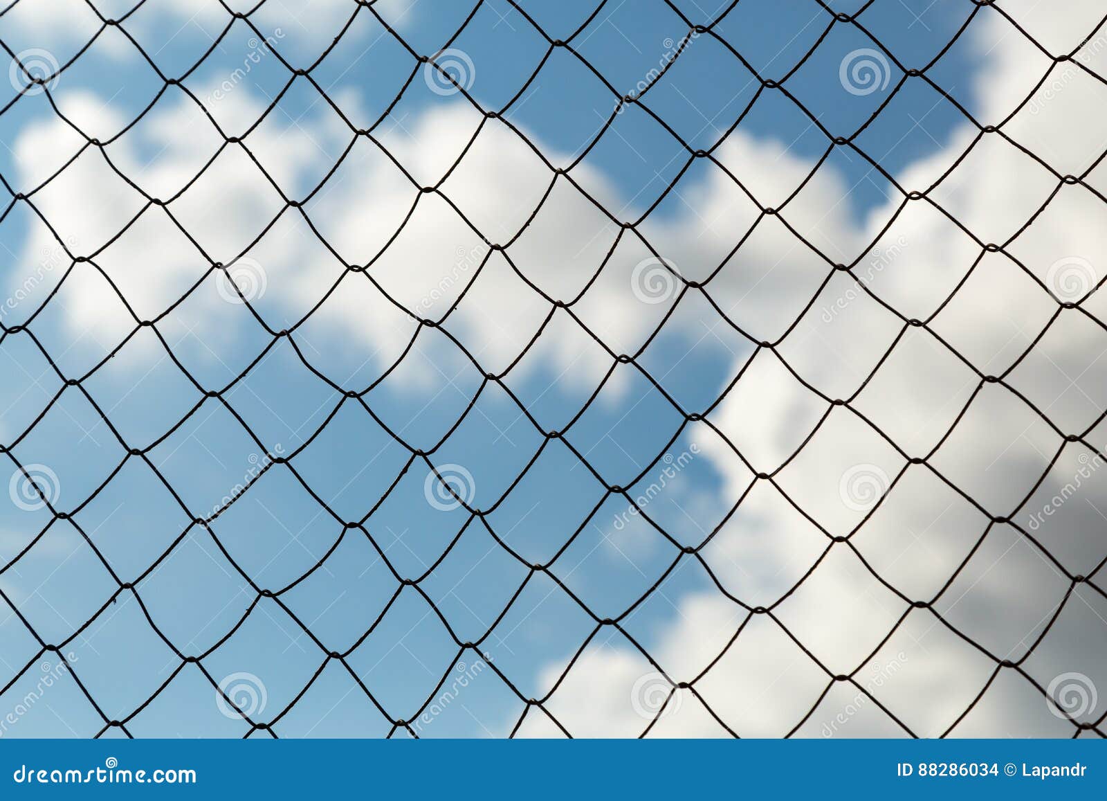 Metal Mesh Netting on the Blue Sky Background and Clouds Stock Photo ...