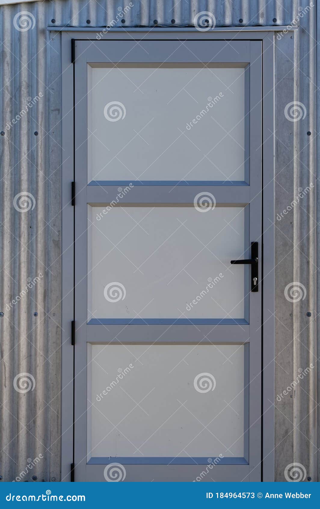 A Metal Panel Door in a Grey Metal Building Stock Image - Image of ...